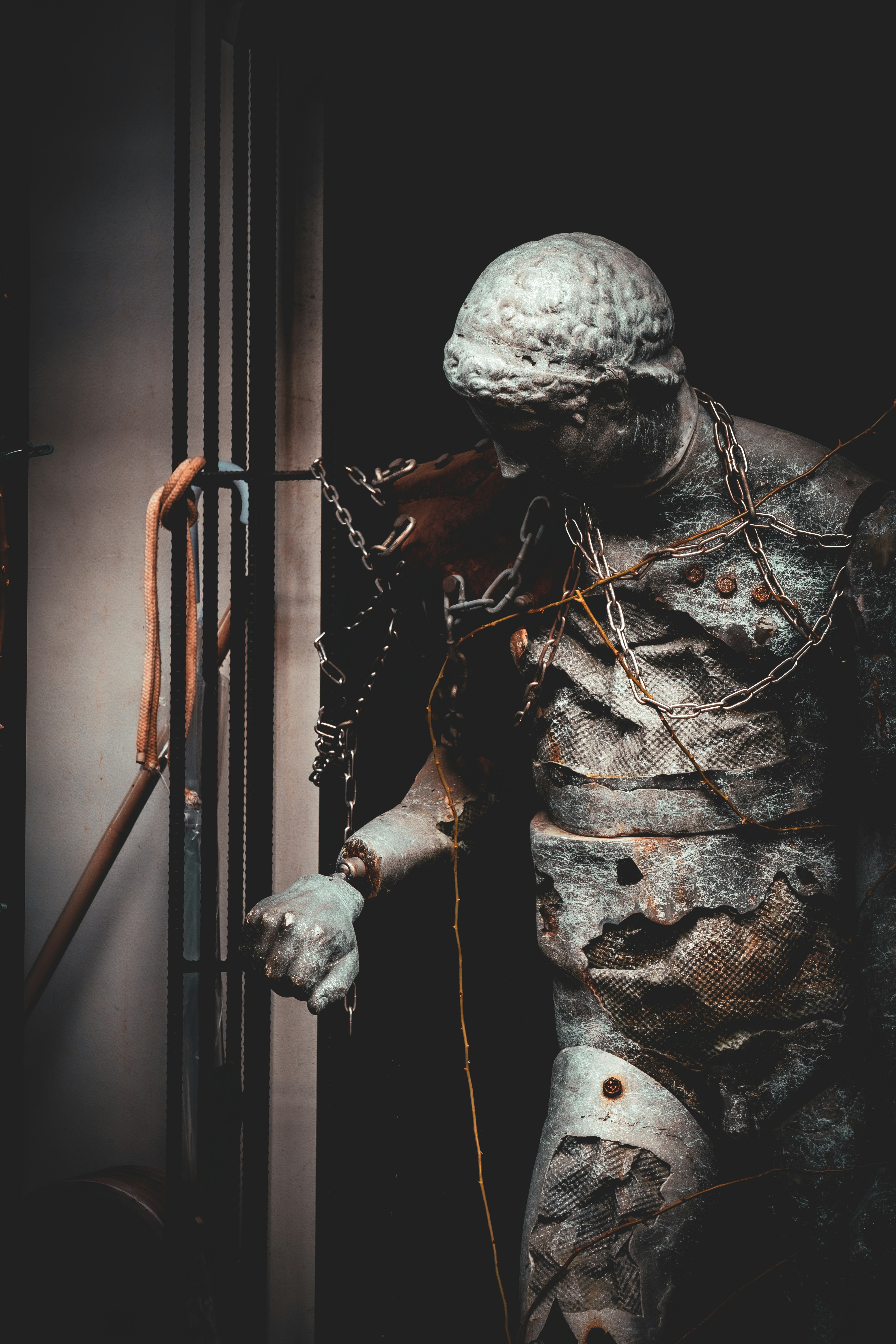 A statue of a man with chains around his neck photo – Free Man Image on ...