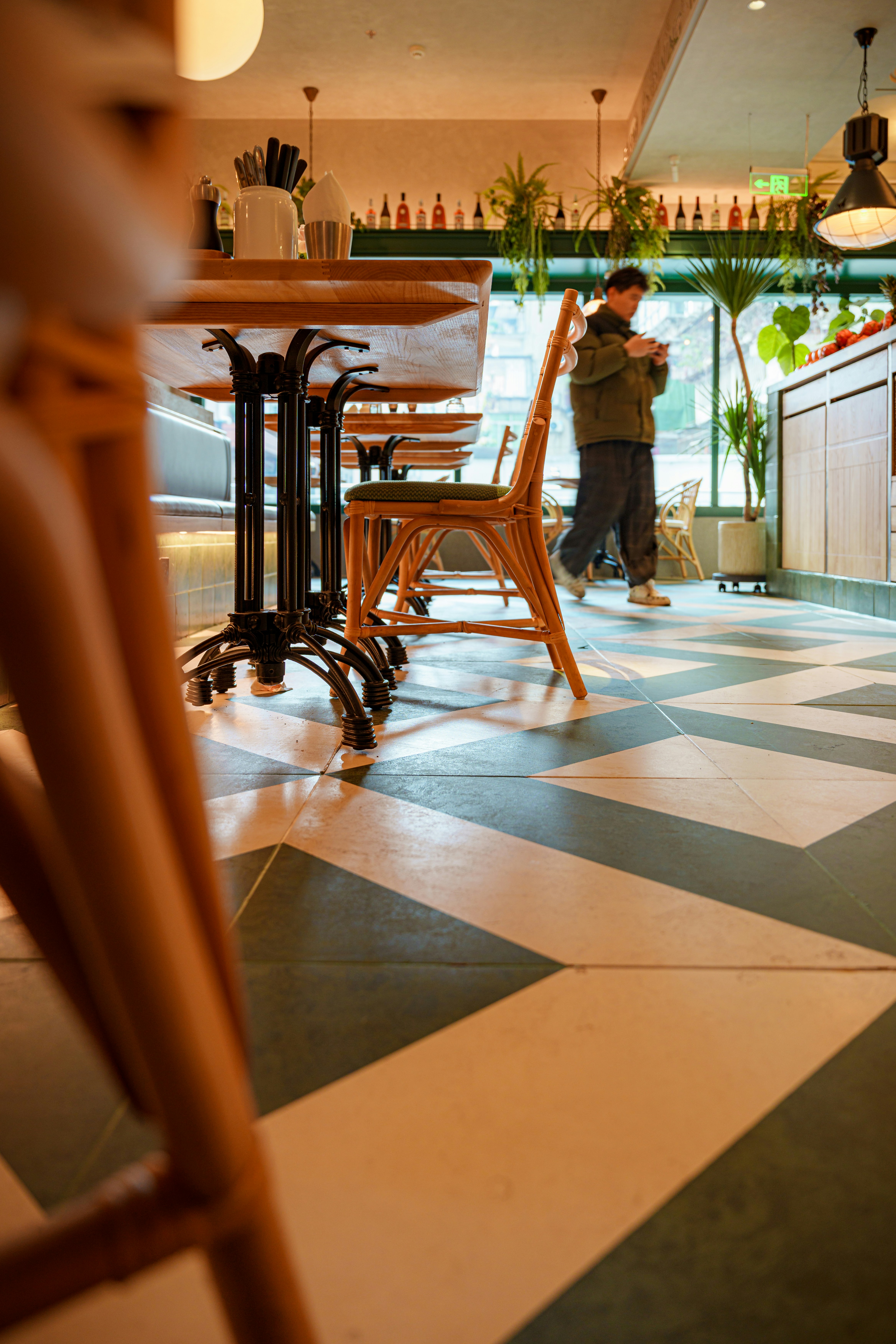 A man standing in a kitchen next to a tableXimin Lin