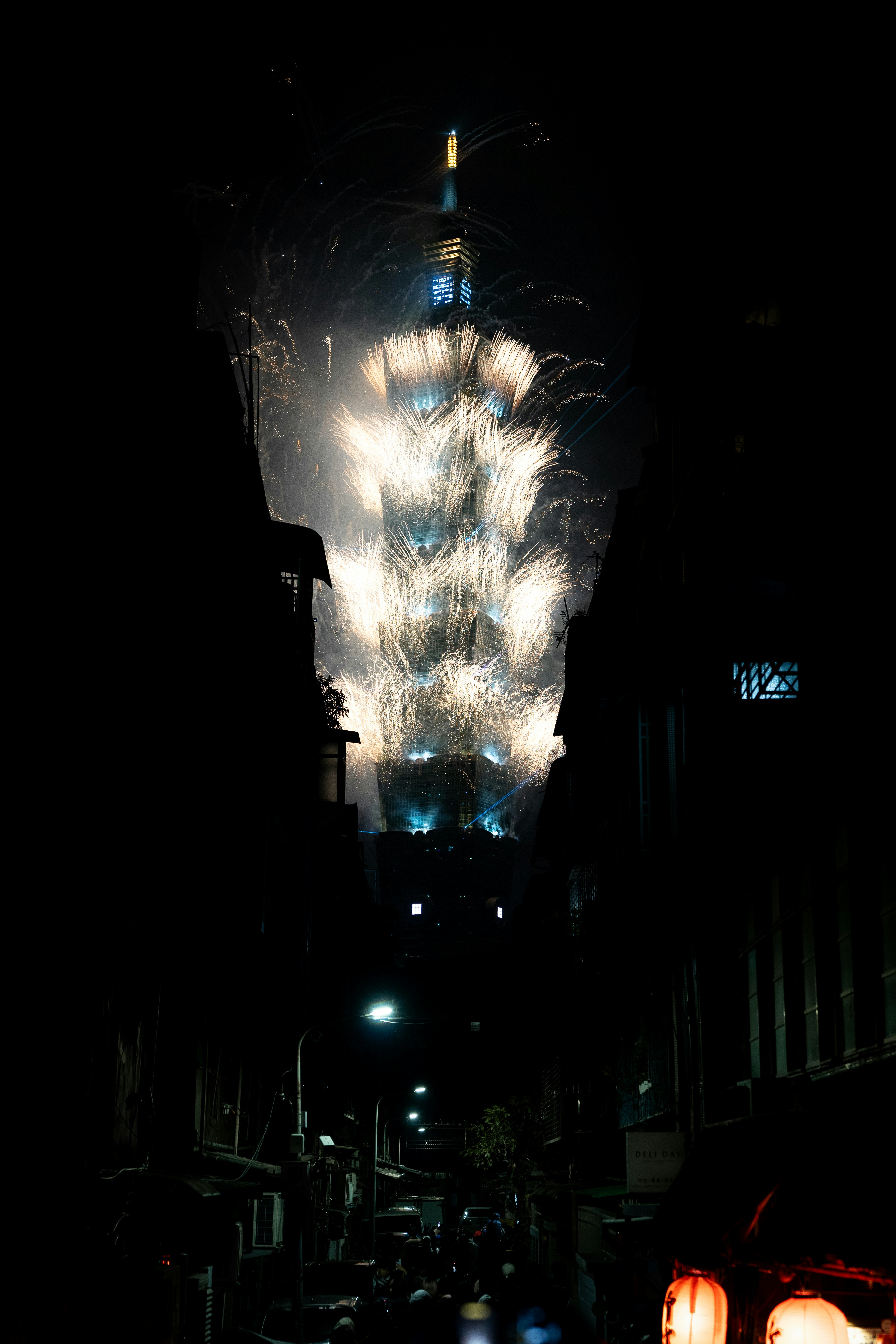 Skyward Sparks: Fireworks Tale Above a Narrow City Alley