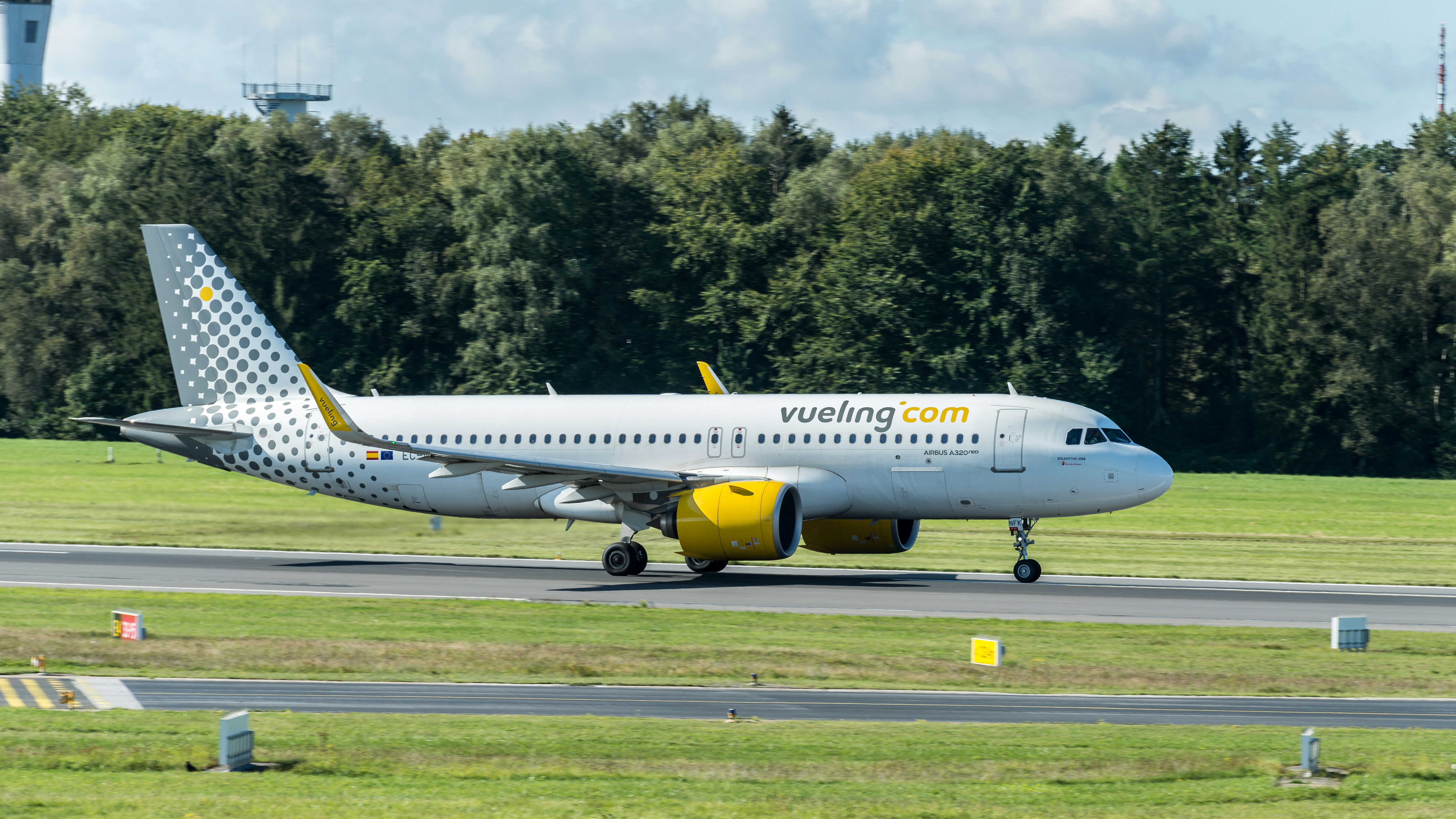 A white and yellow plane is on a runway photo – Free Hamburg Image on ...