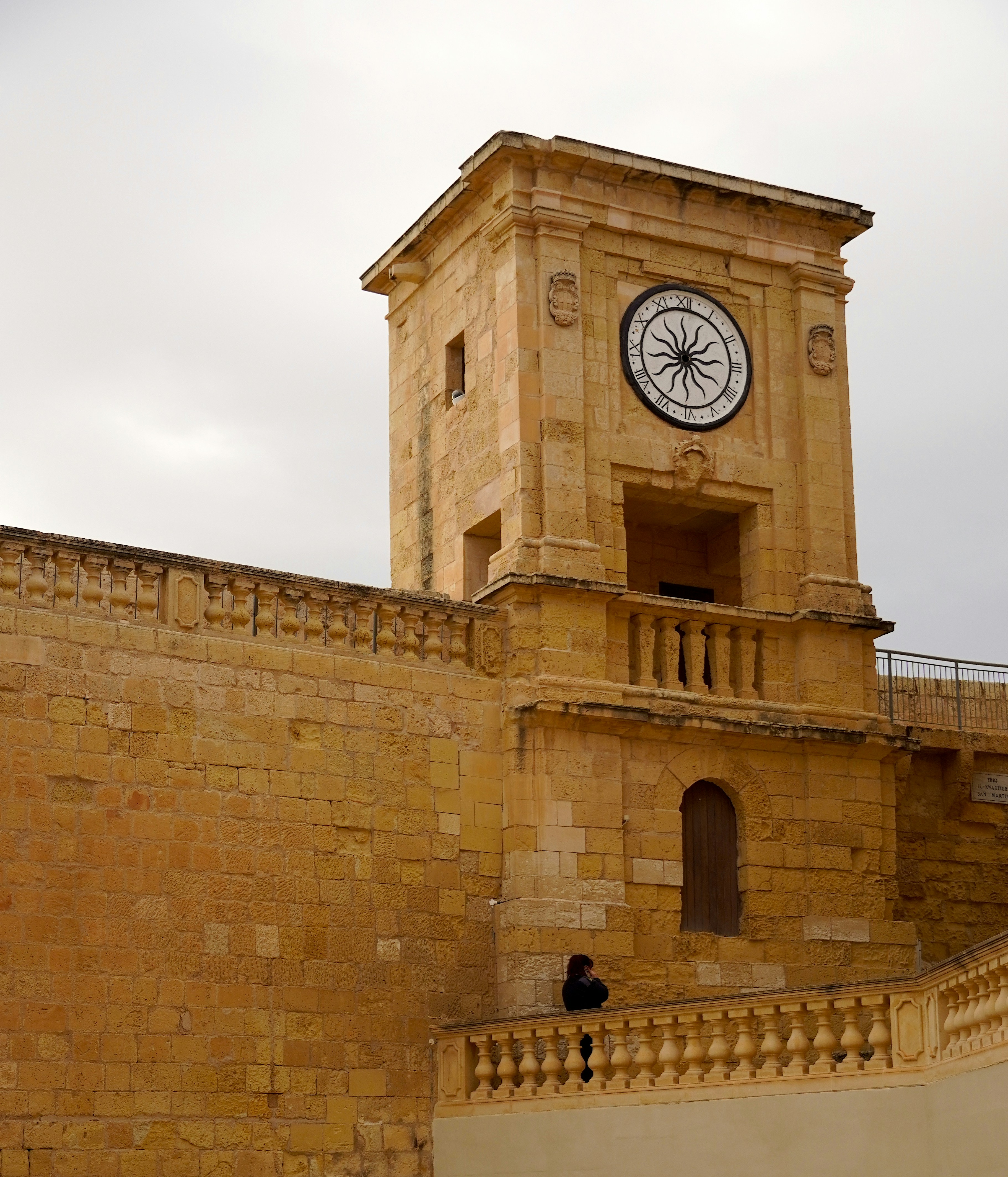 Clock Tower of the Sunlit Bastion: Limestone Facade and Quiet Balcony