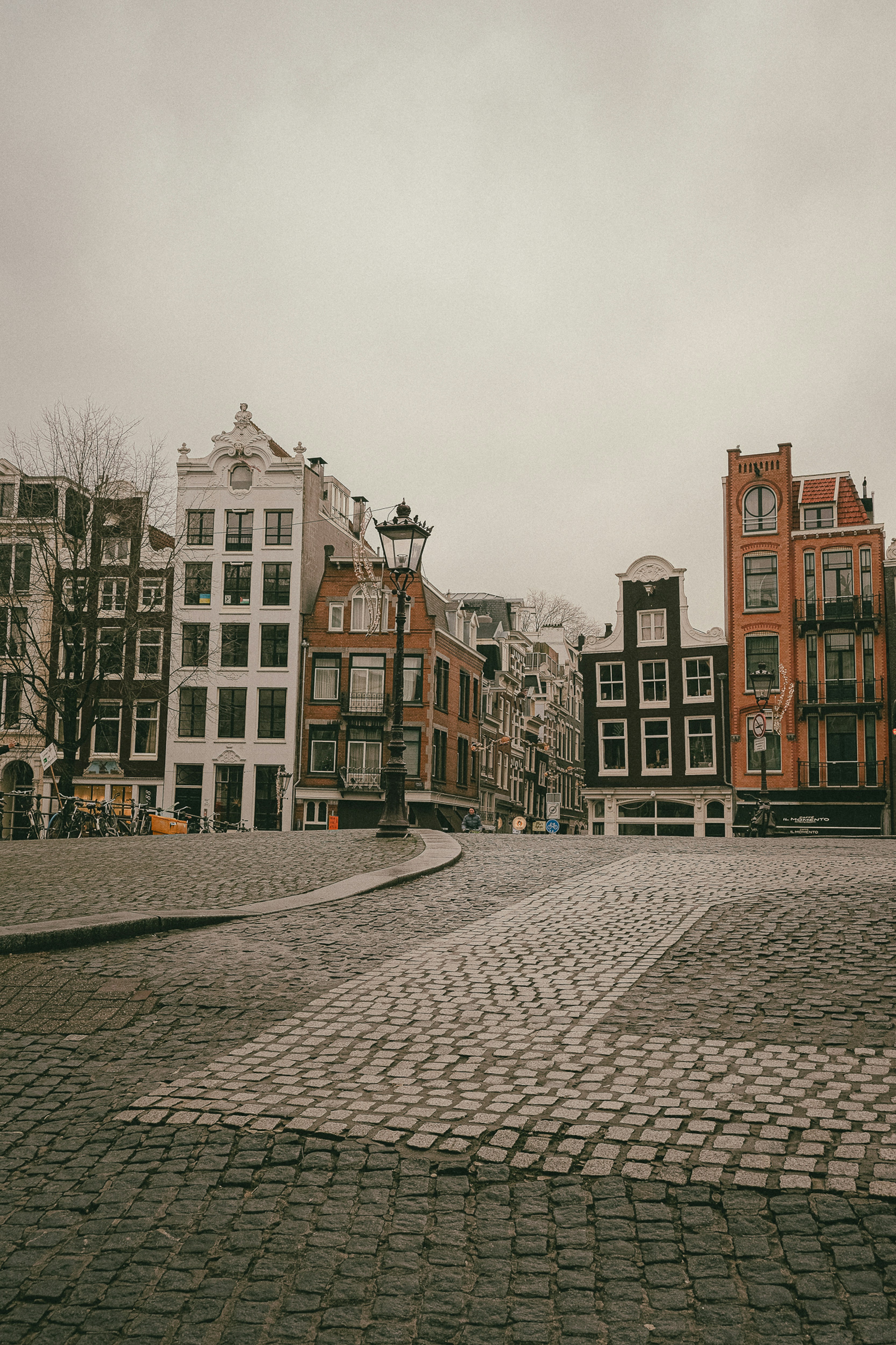 Lamplight at the Cobblestone Curve: Quiet Dutch Street in Fog