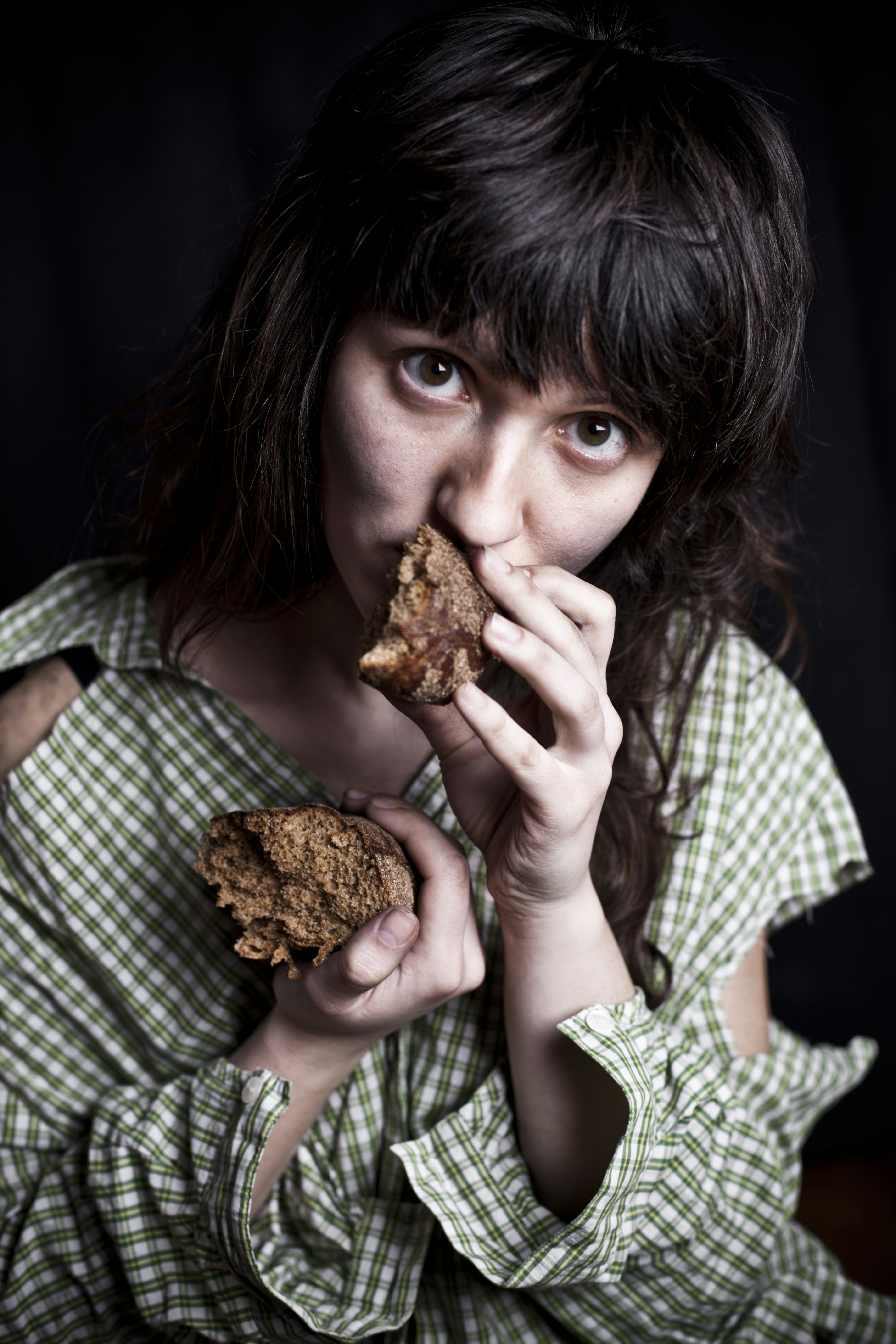 A woman in a green dress eating a cookie photo – Free Food Image on ...