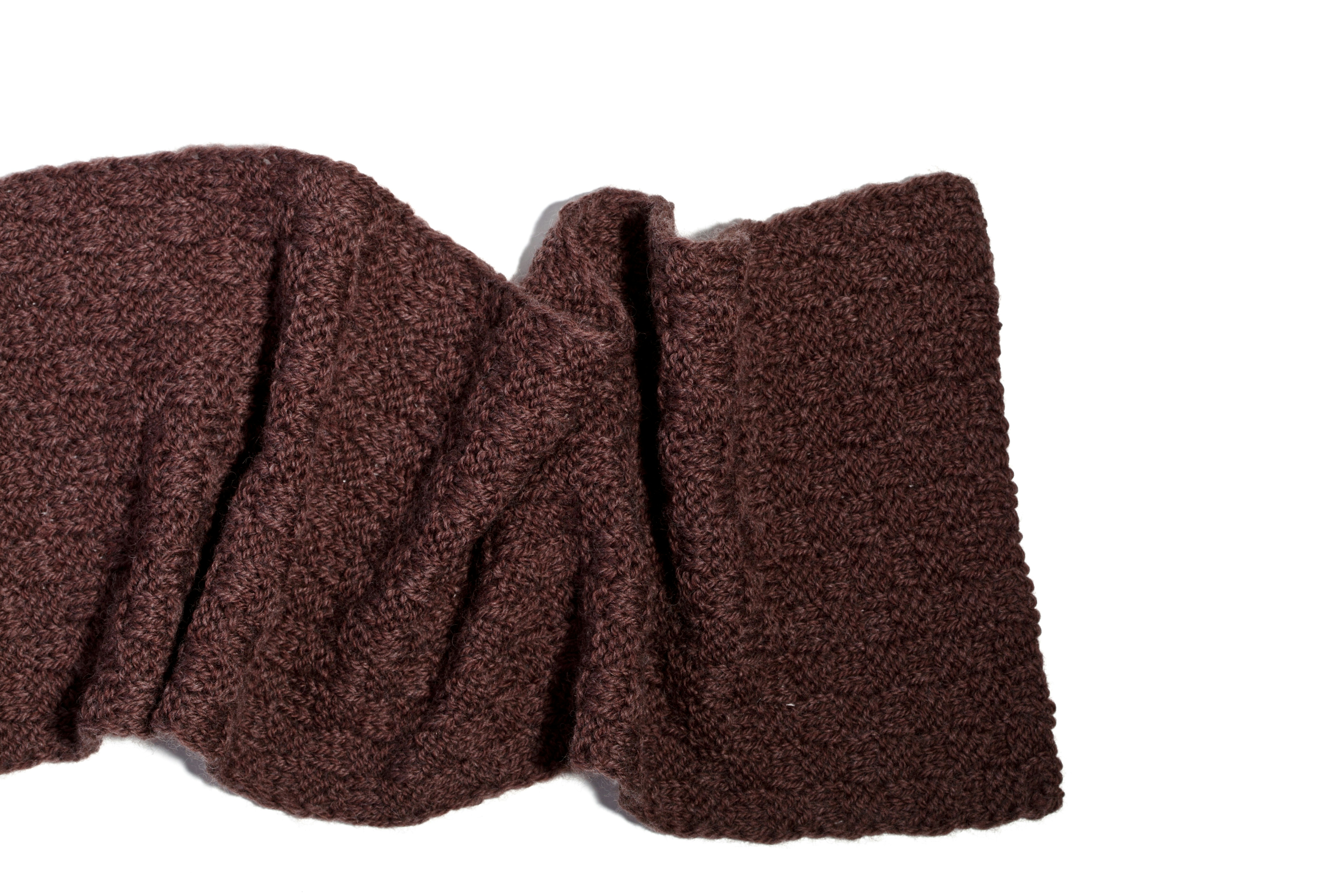 Maroon Fold: Texture and Light on White Backdrop