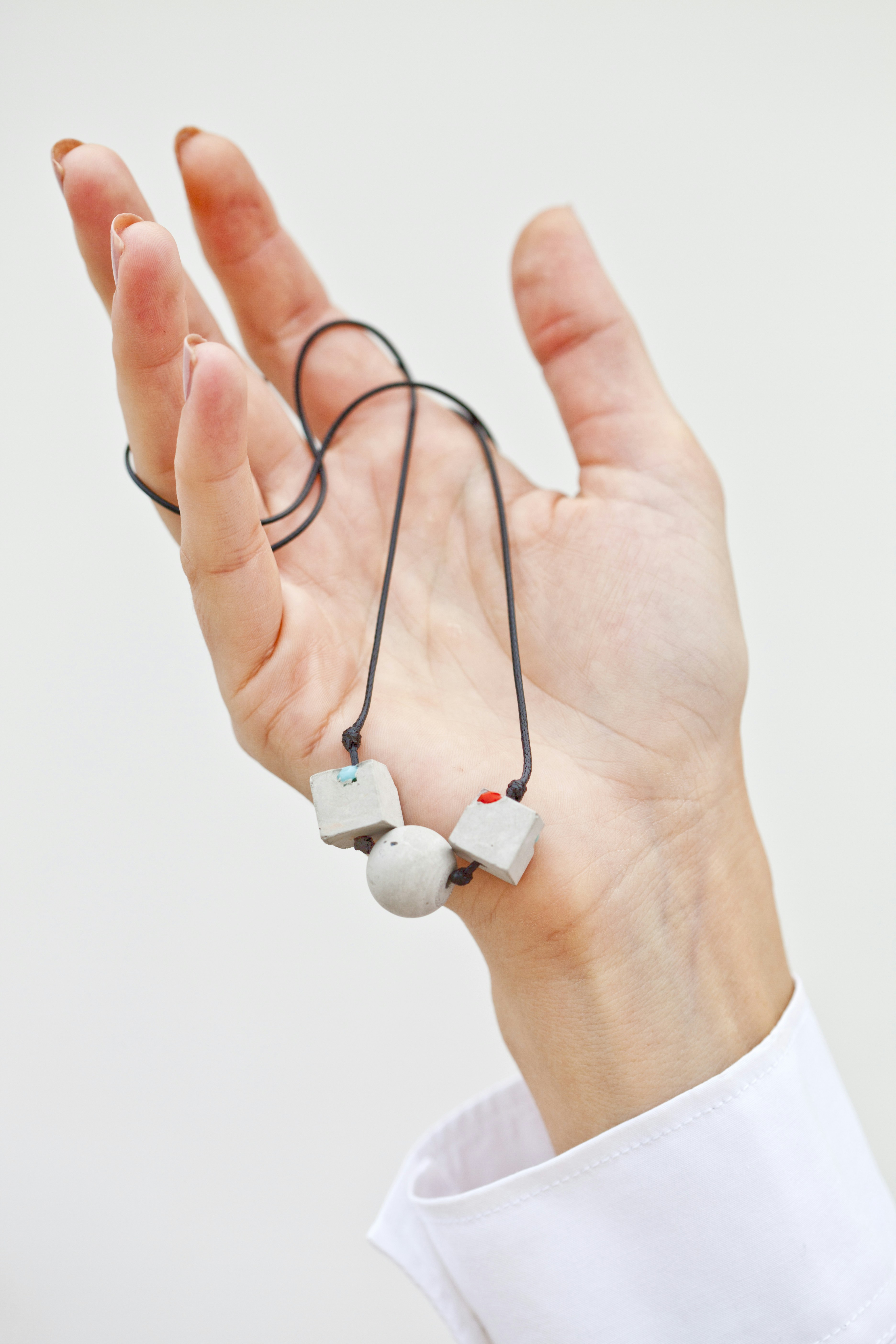 A person holding their hand up with a string attached to it photo ...