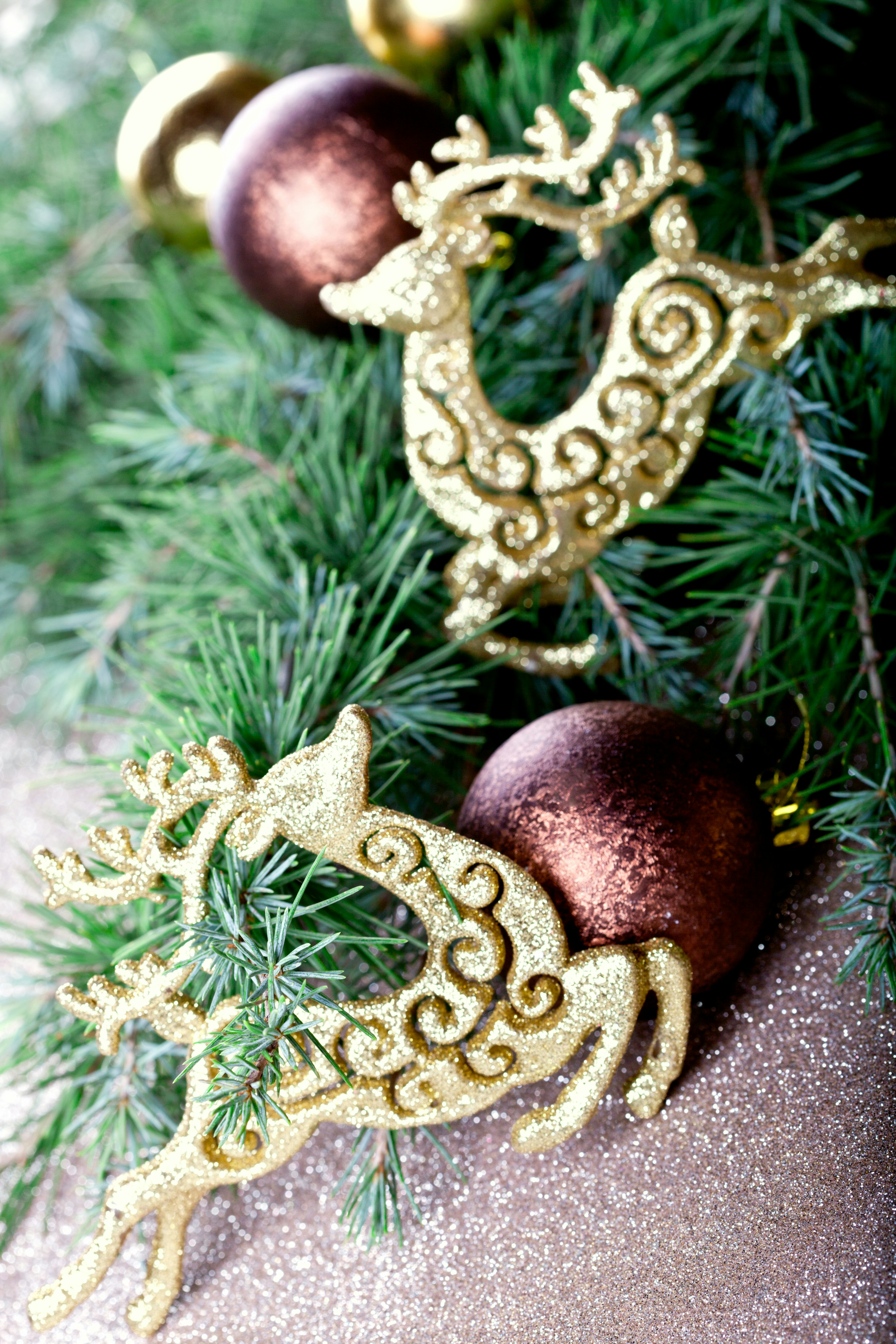 Golden Reindeer Ornaments on a Frosted Green Fir