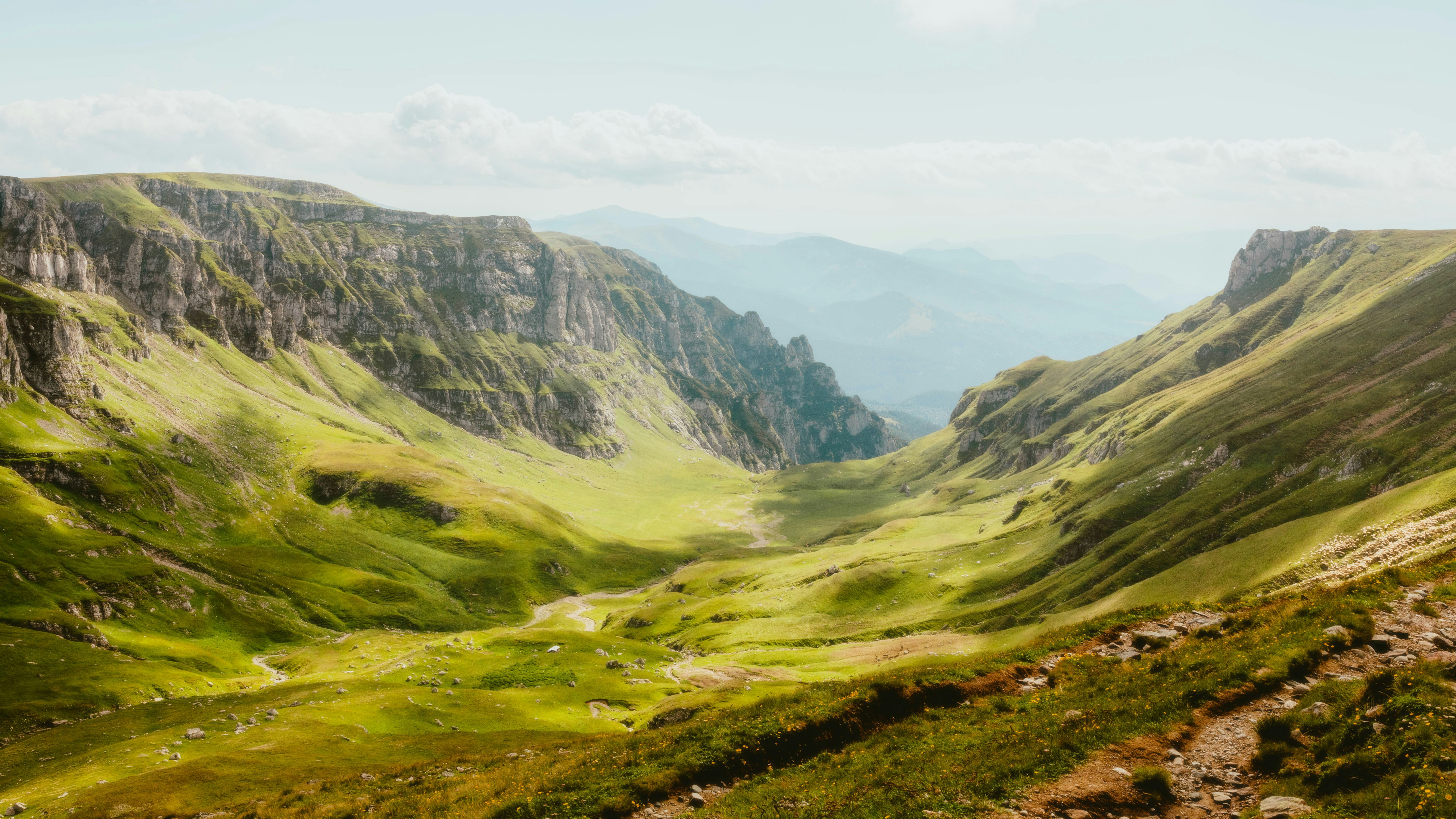 A view of a valley with mountains in the background photo – Free ...