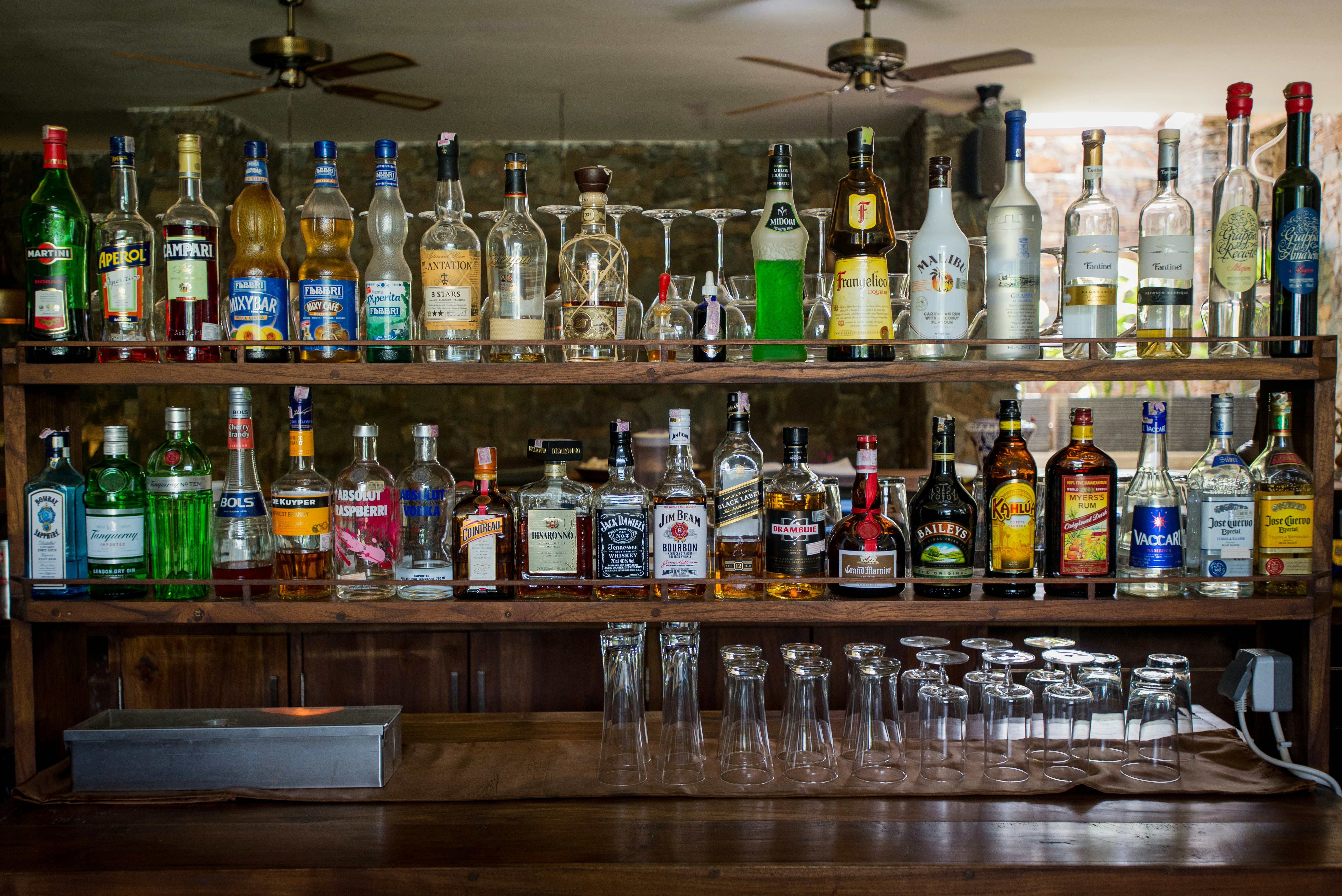 A bar filled with lots of bottles and glasses photo – Free Labuan bajo ...
