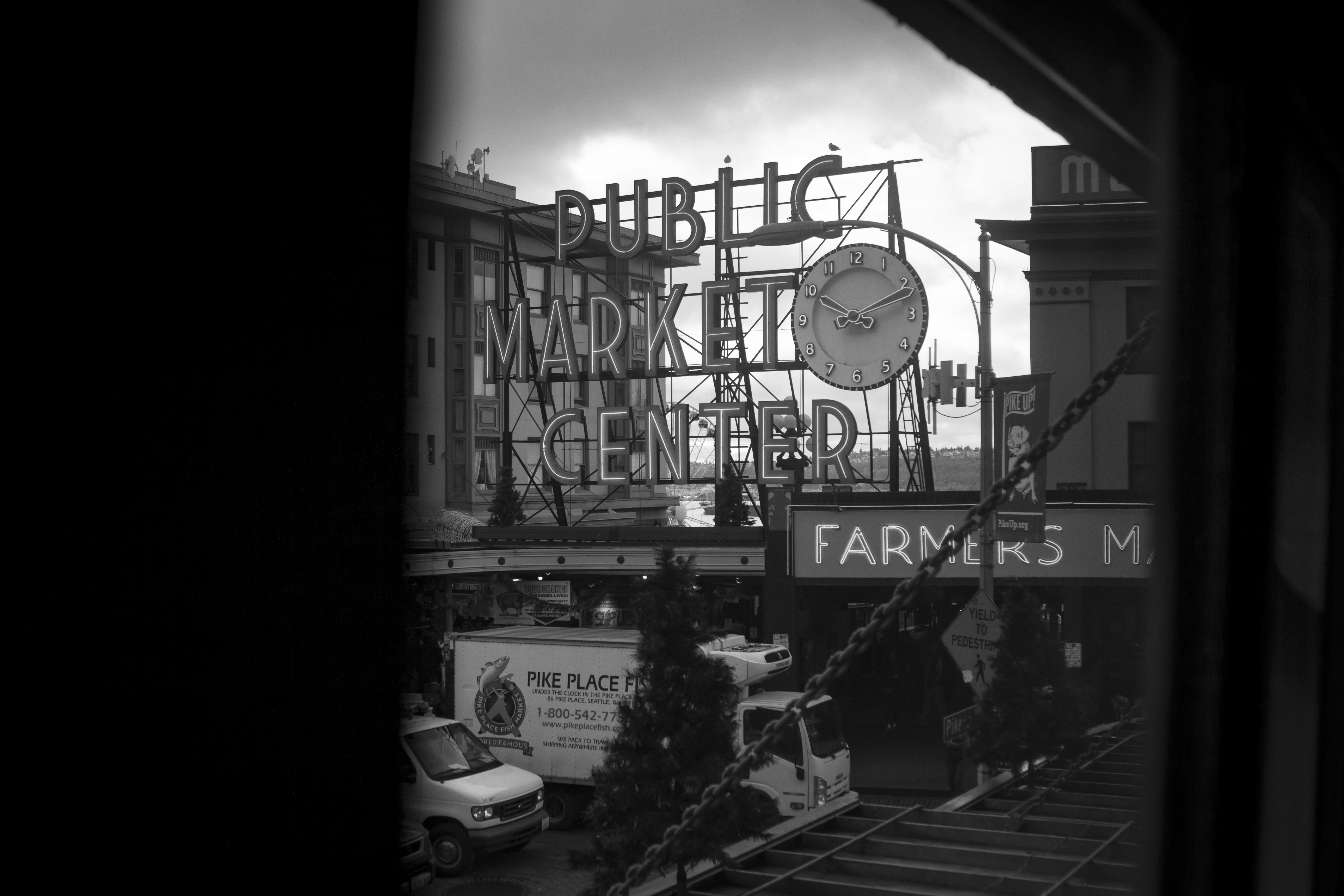 Neon Sign Across a City Market Window