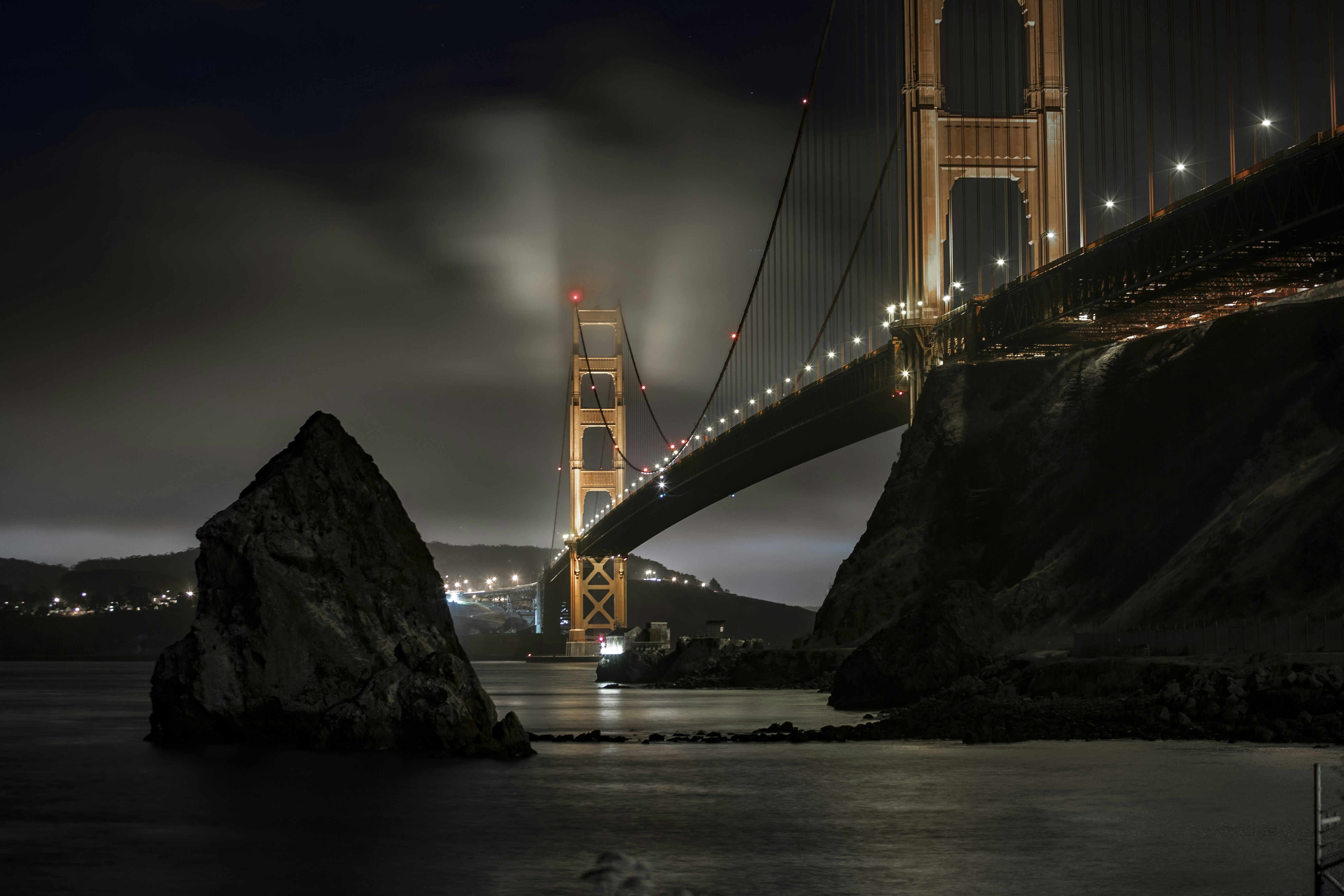 The golden gate bridge is lit up at night photo – Free Golden Image on ...