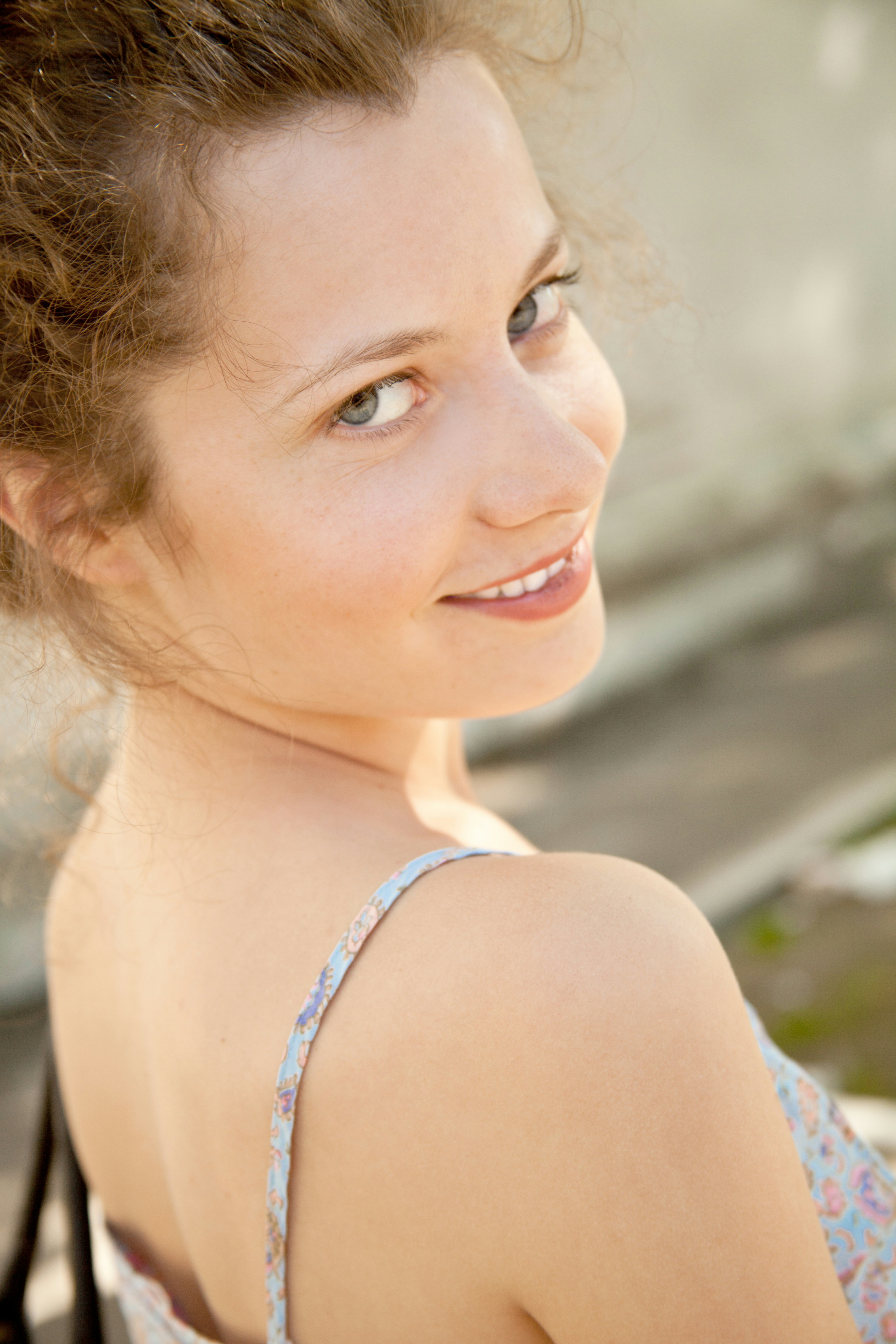 A young woman is smiling while holding a cell phone photo – Free Woman ...