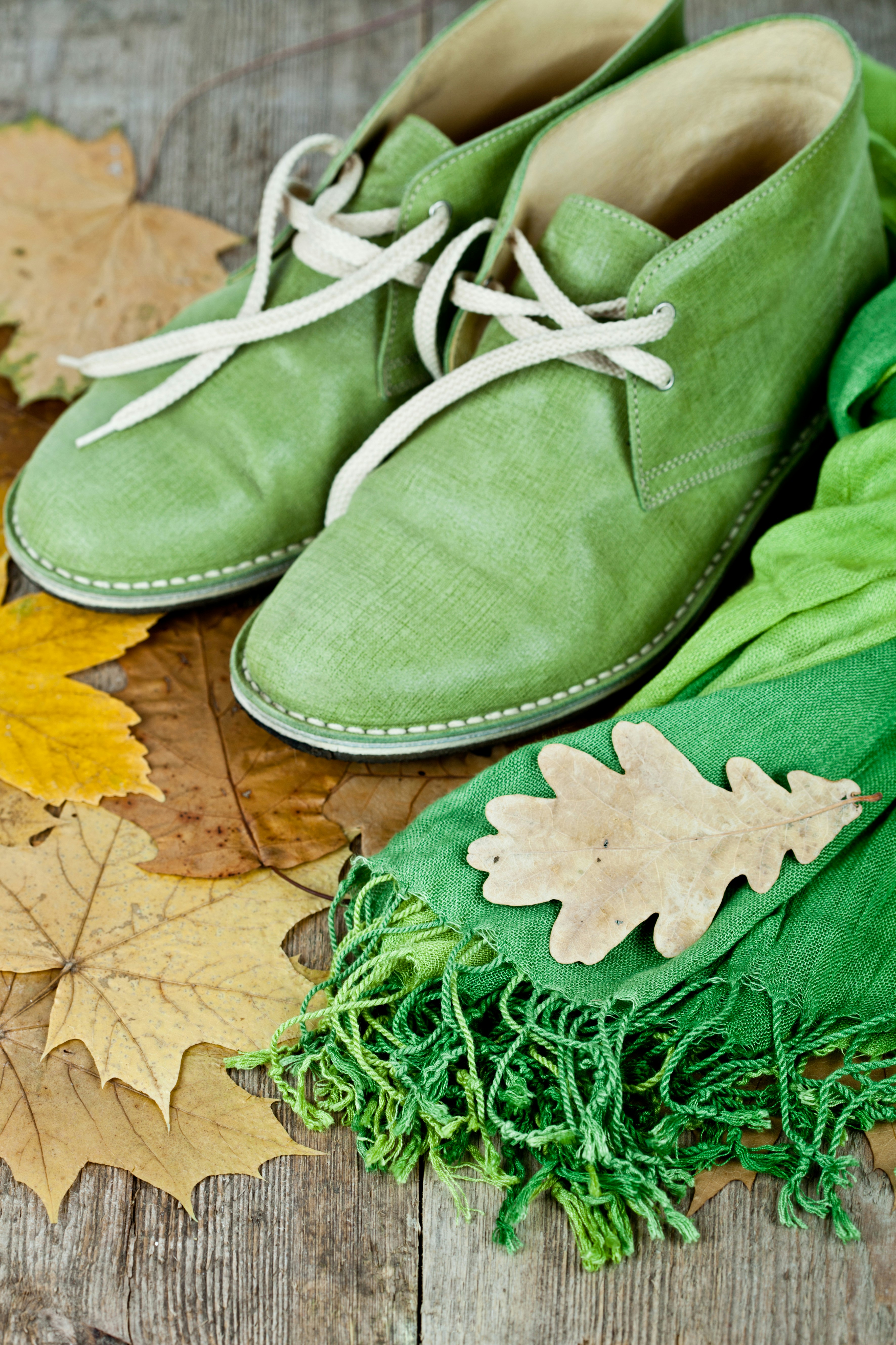 Verdant Steps: Green Shoes Among Autumn Leaves