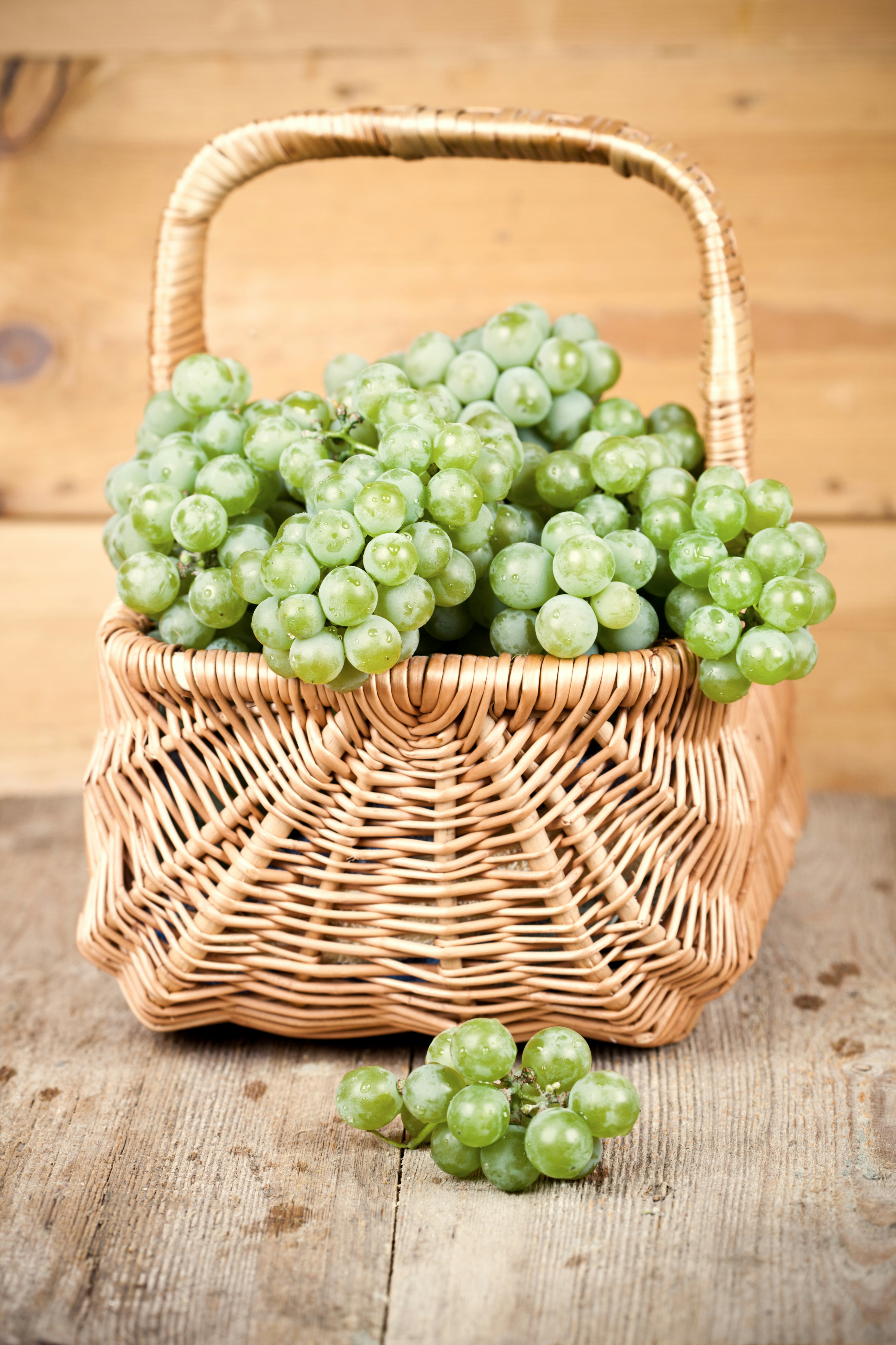 Sunlit Green Grapes in a Woven Basket