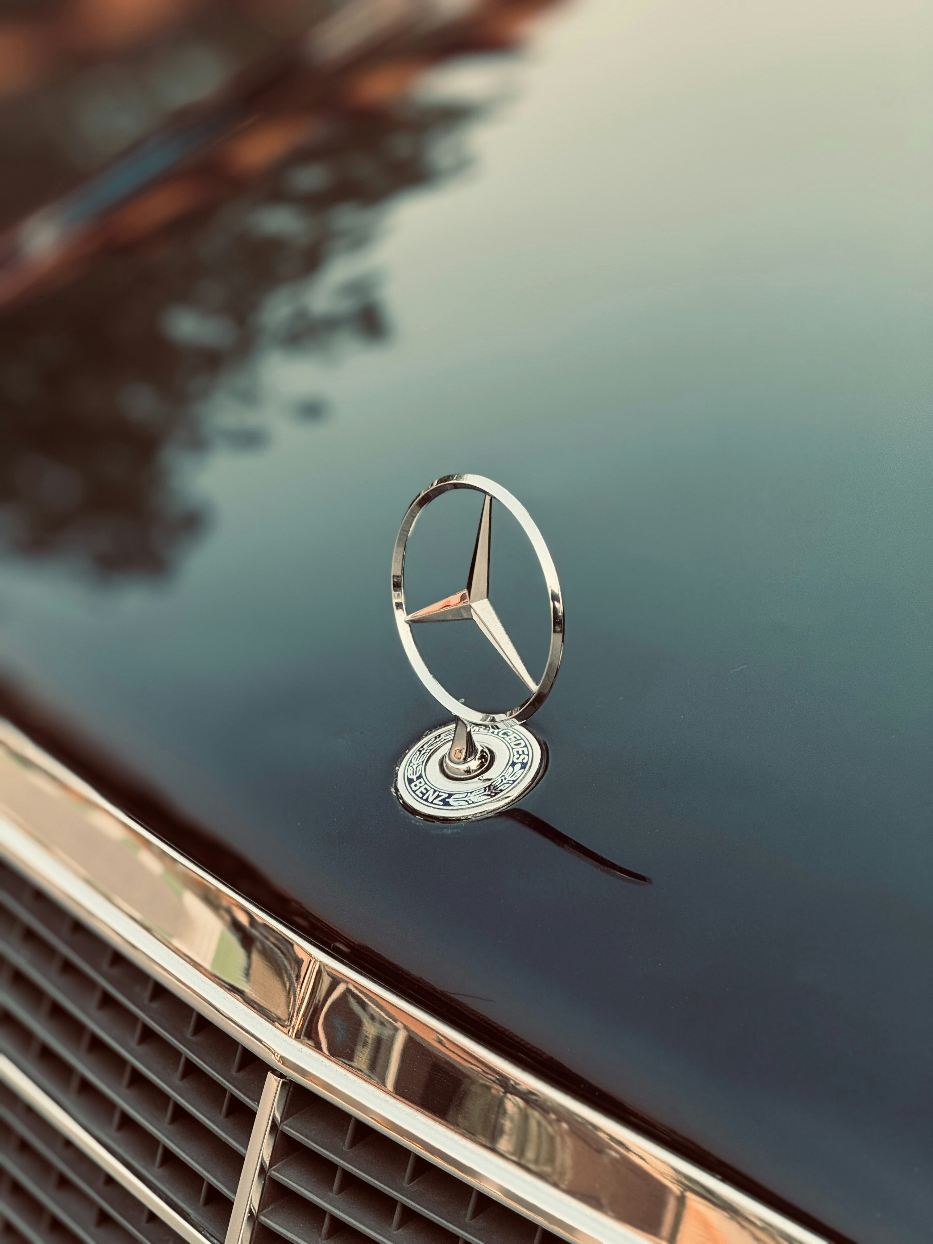 Chrome Halo on a Midnight Hood: The Mercedes-Benz Emblem in Quiet Focus