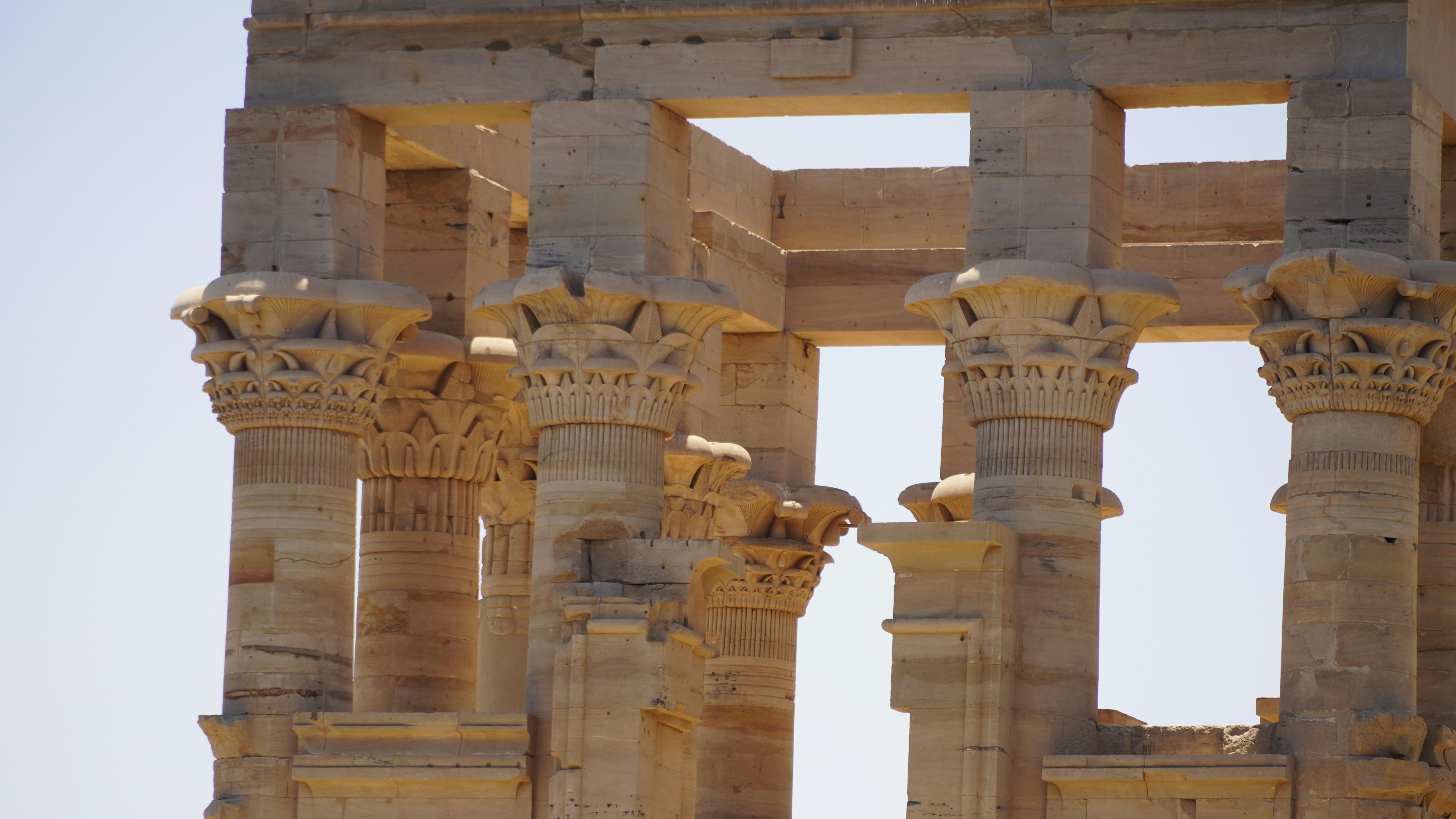 A large stone structure with columns and a sky background photo – Free ...