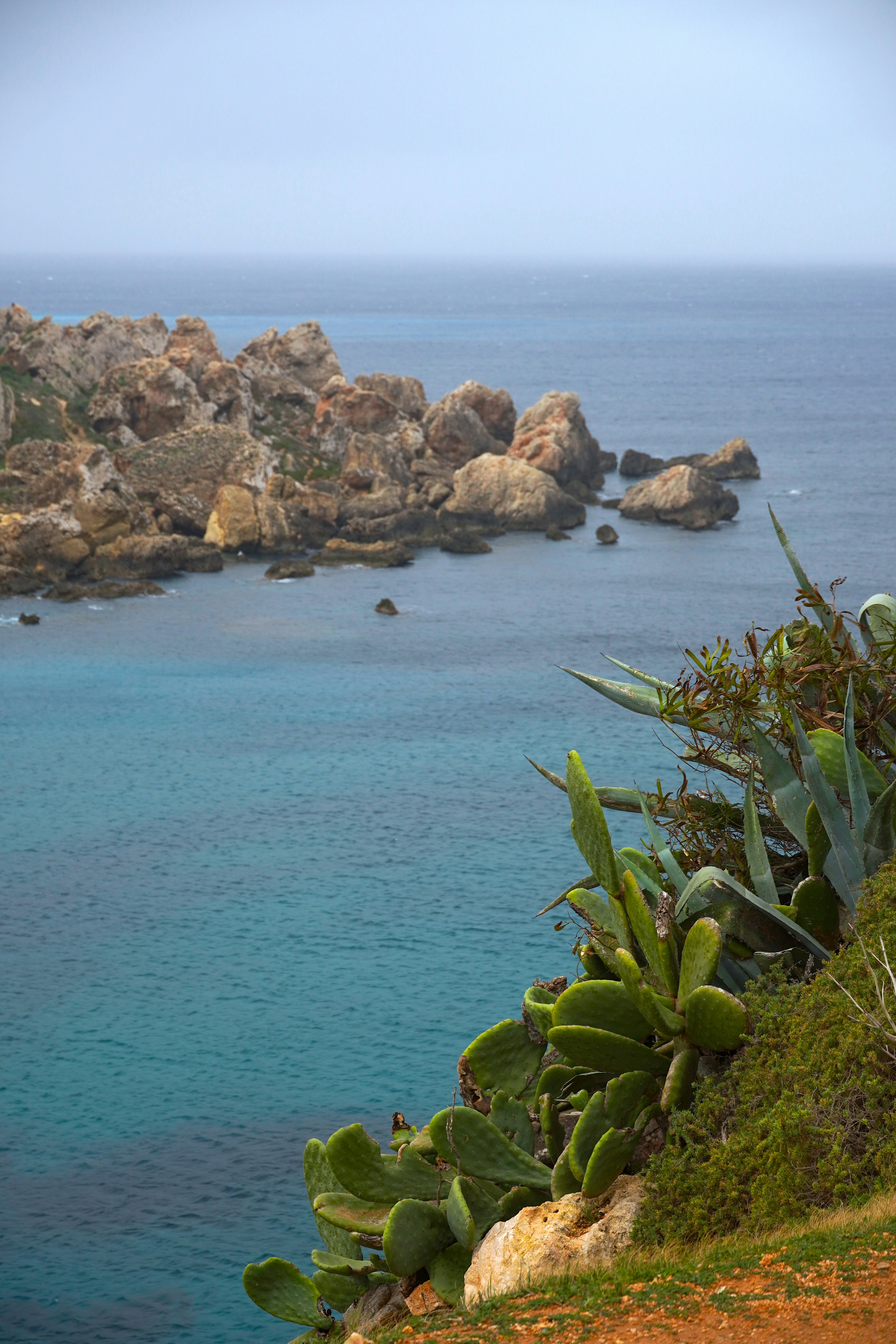 A body of water with rocks in the background photo – Free Riviera beach ...