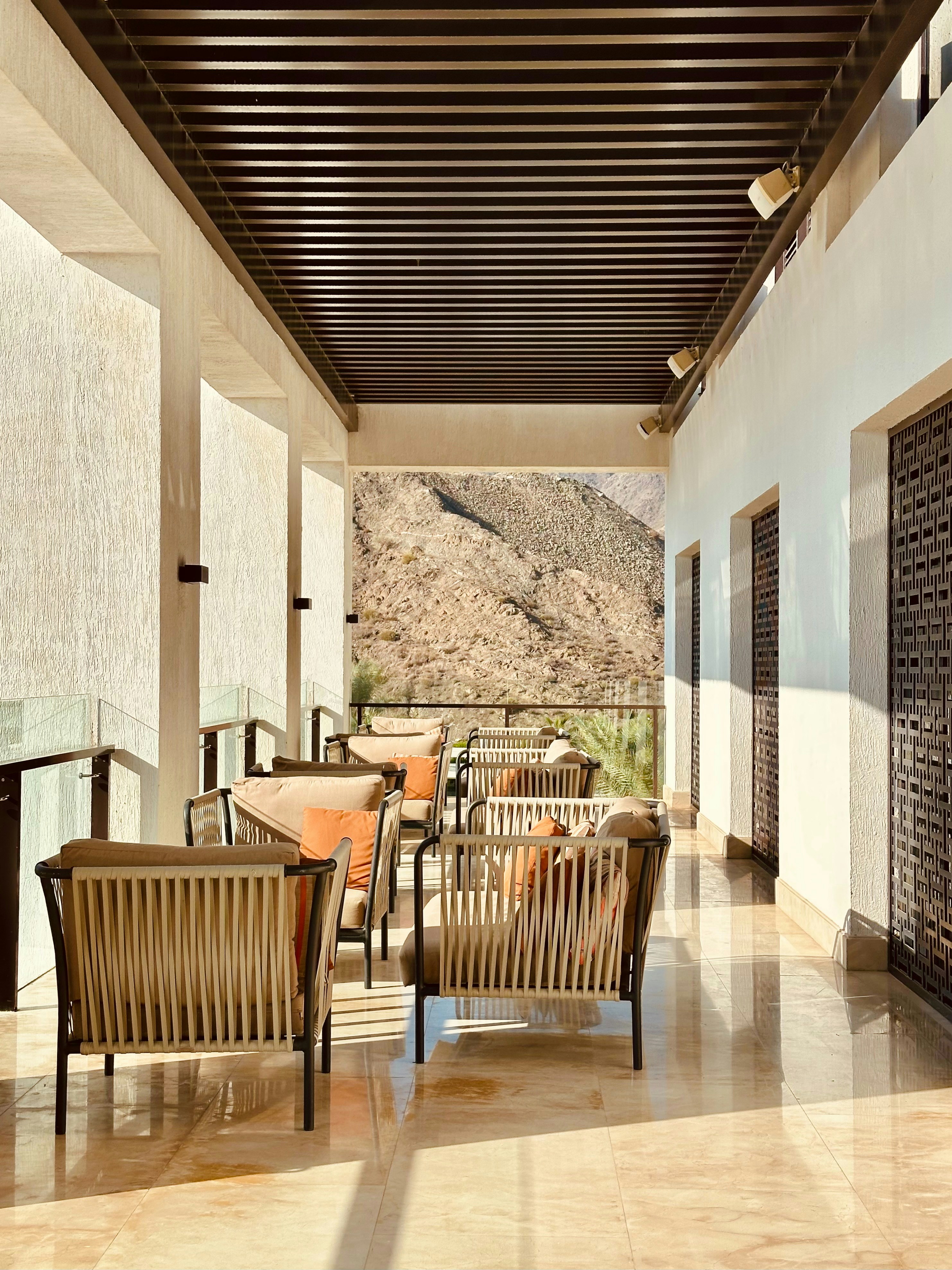Sunlit Veranda Lounge Framing a Mountain Vista