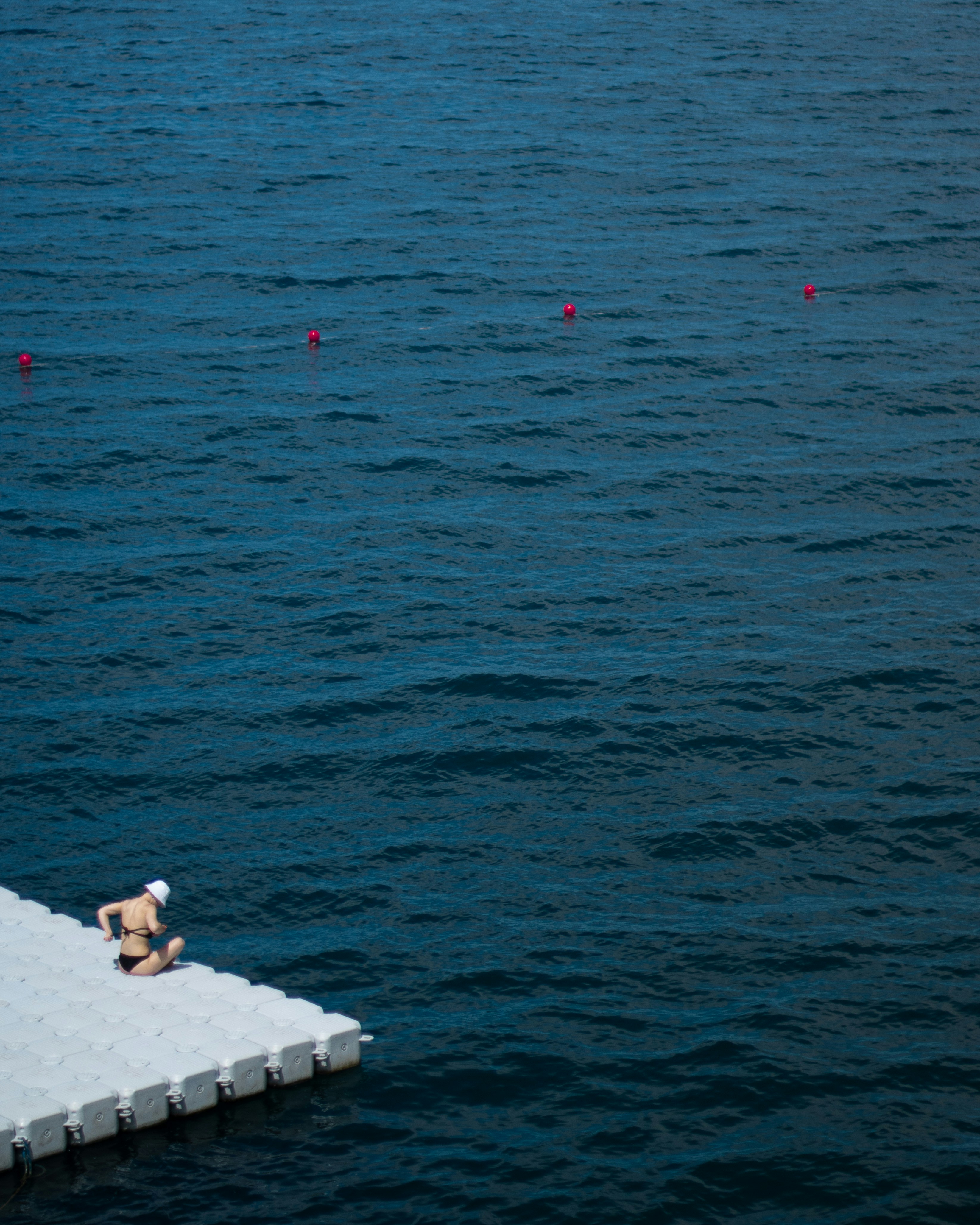 Solitary Dockside Moment on Indigo Sea