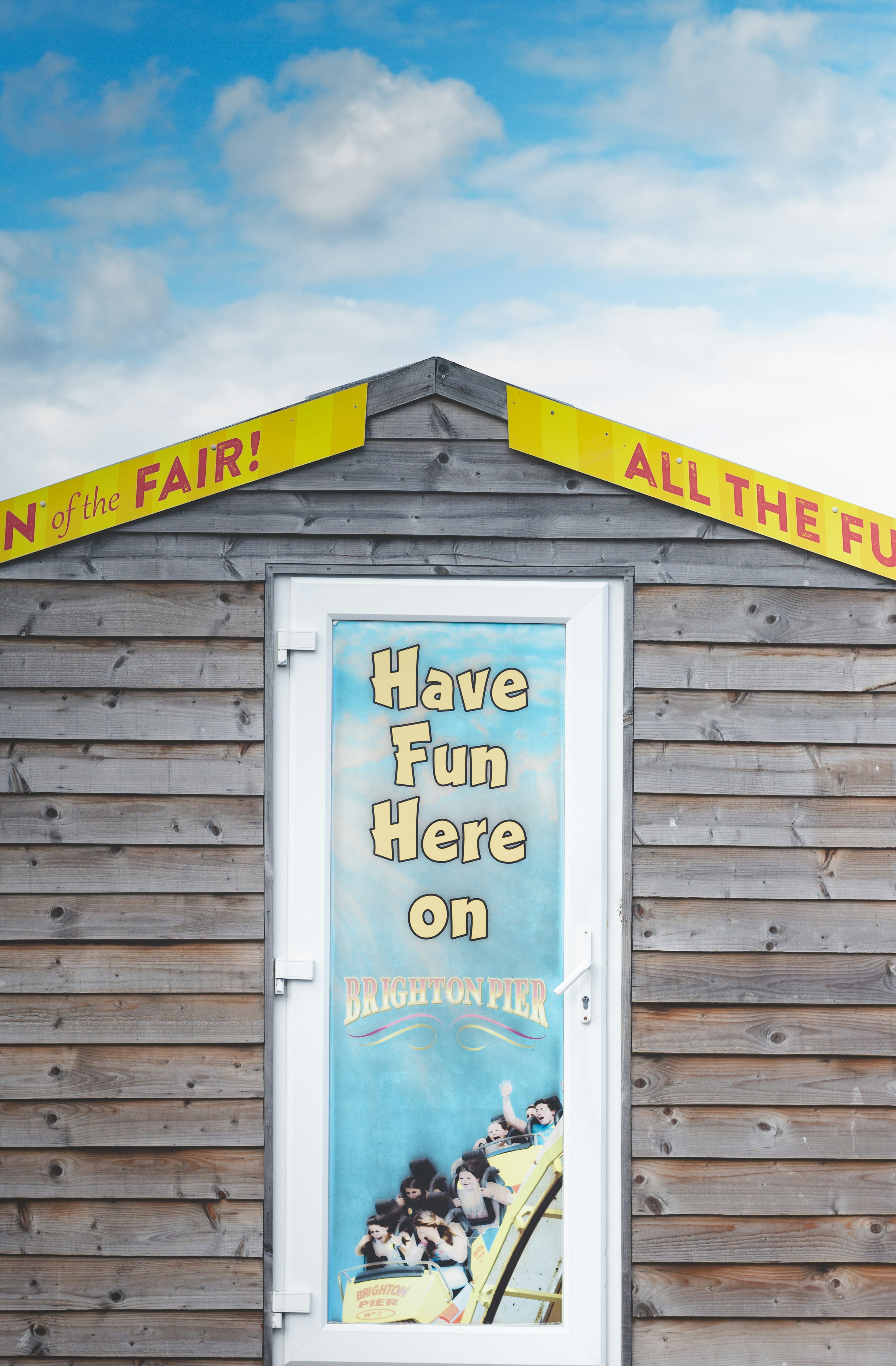 Have Fun Here: A Weathered Doorway Framed by Bright Promos