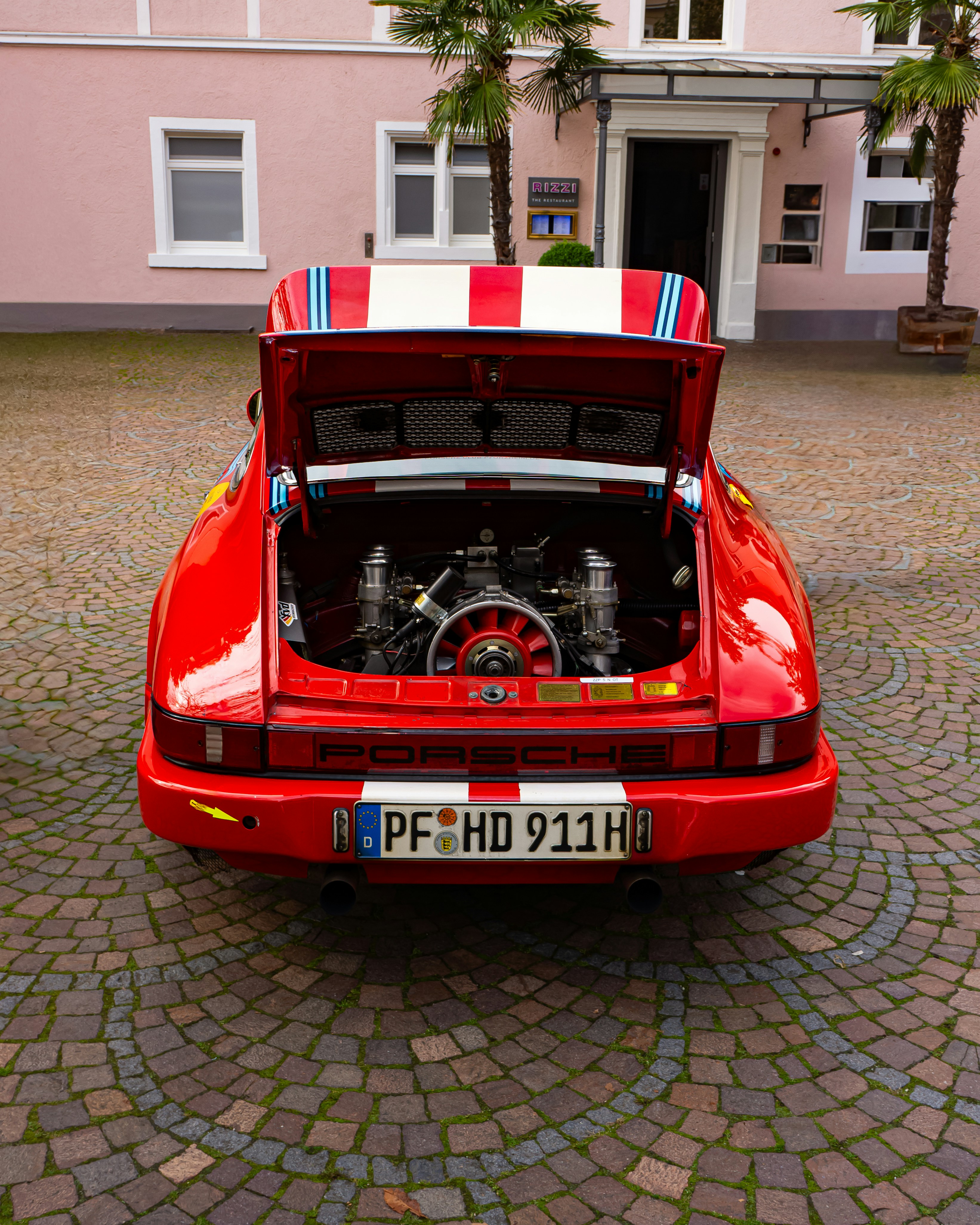 Vibrant Porsche Elegance in Classic Courtyard