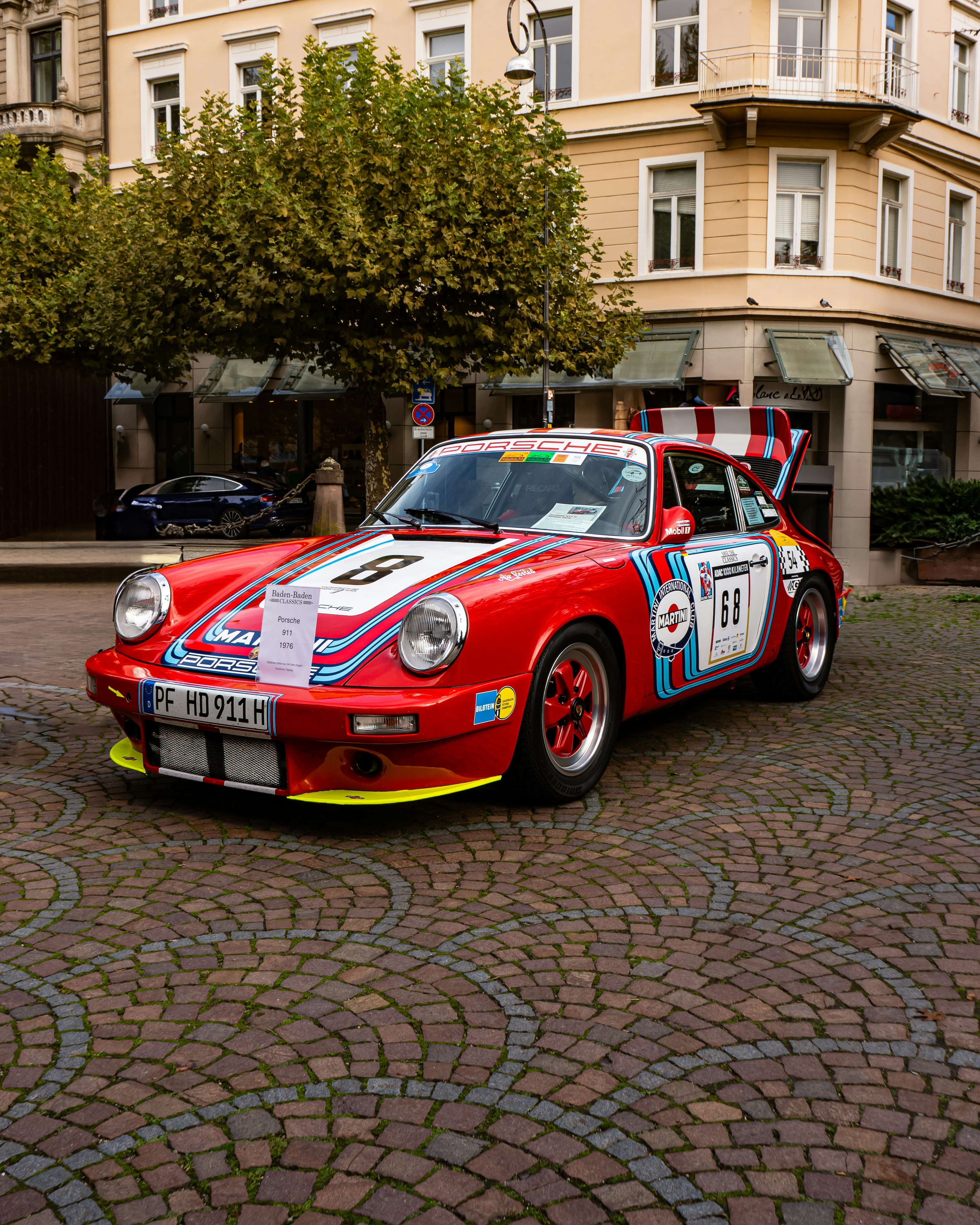 Crimson Rally Porsche 911 on a Cobbled Plaza