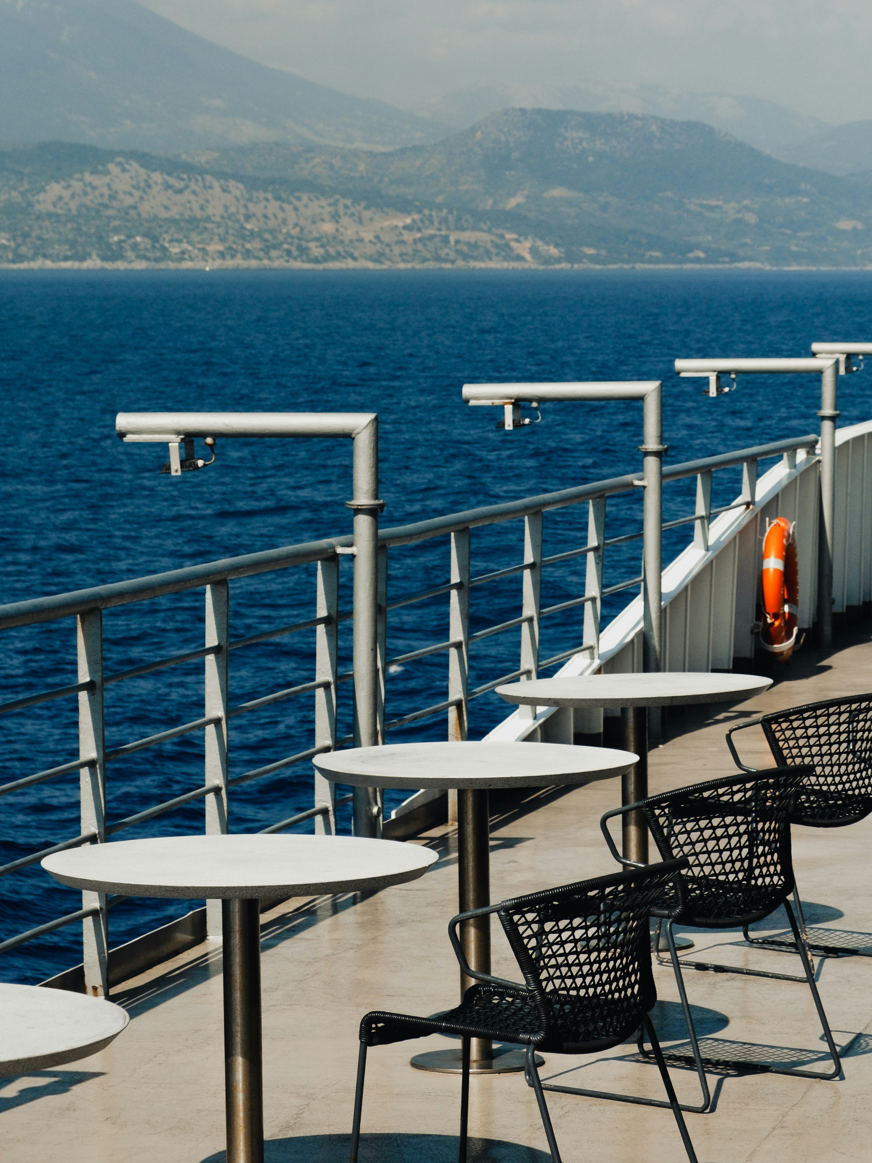 Lifebuoy Luminosity: A Seaside Pier's Quiet Row of Tables