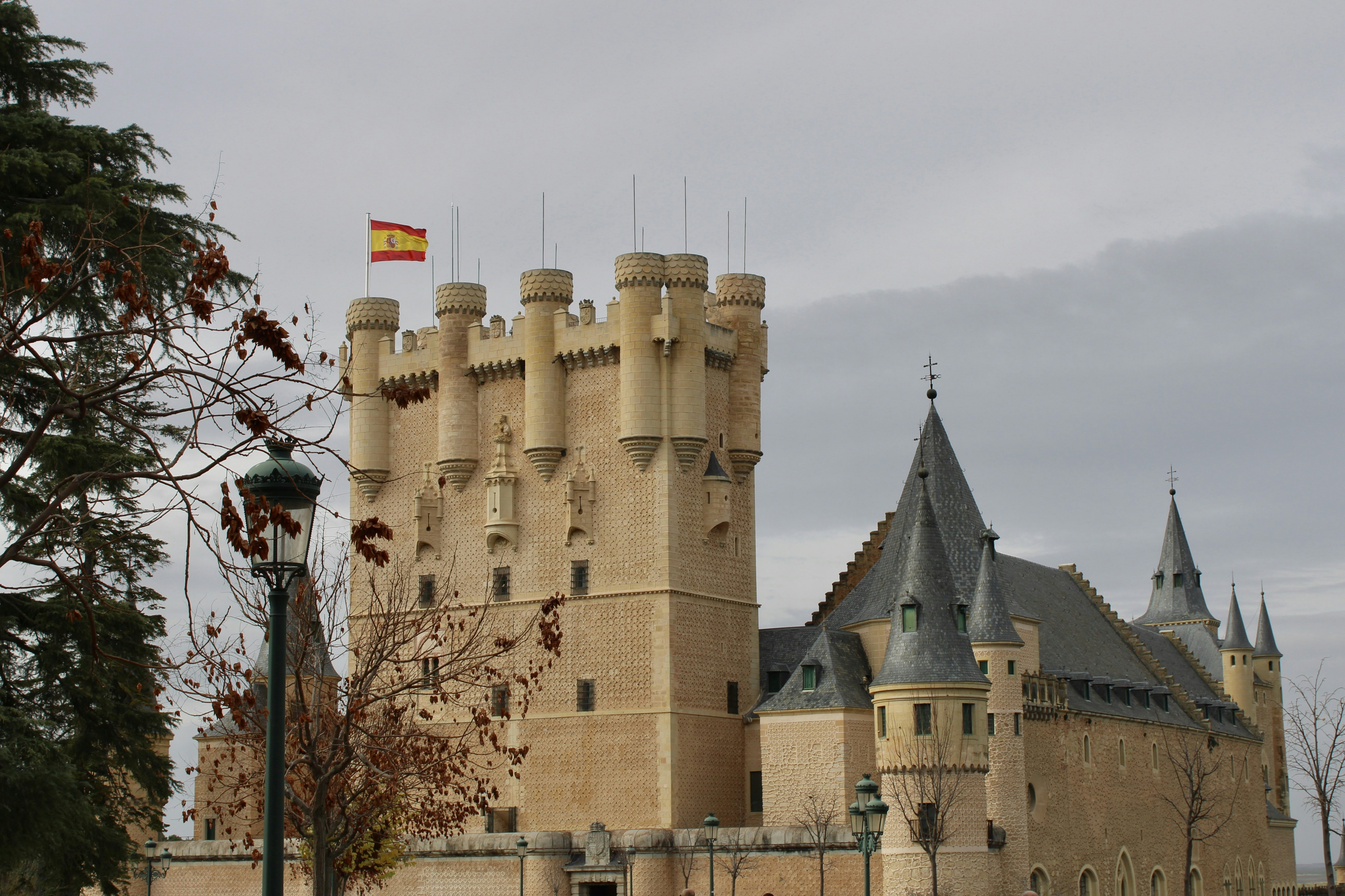 Castle Walls and Turrets Under a Flagged Sky