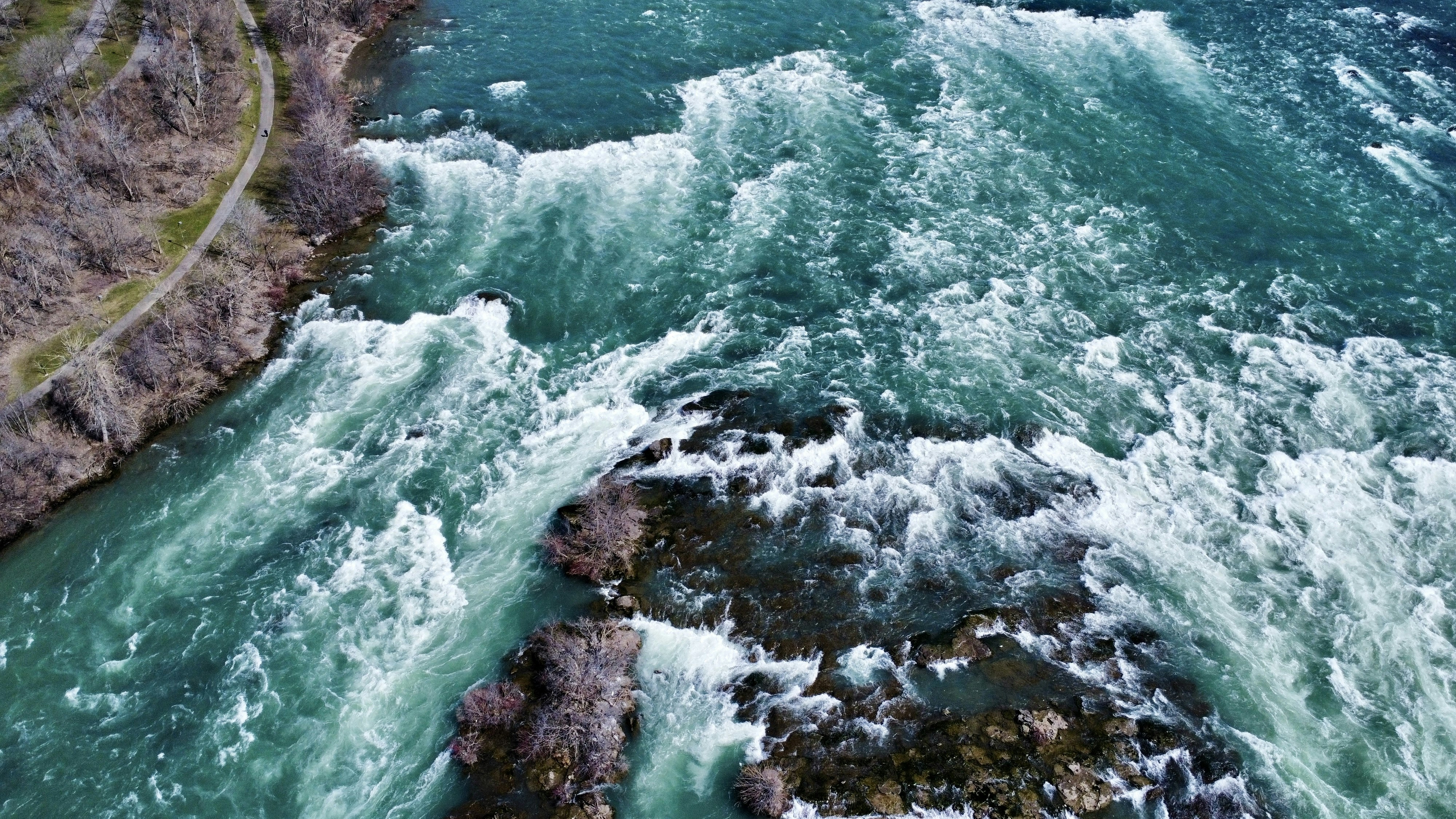 A large body of water surrounded by rocks photo – Free Niagara falls ...