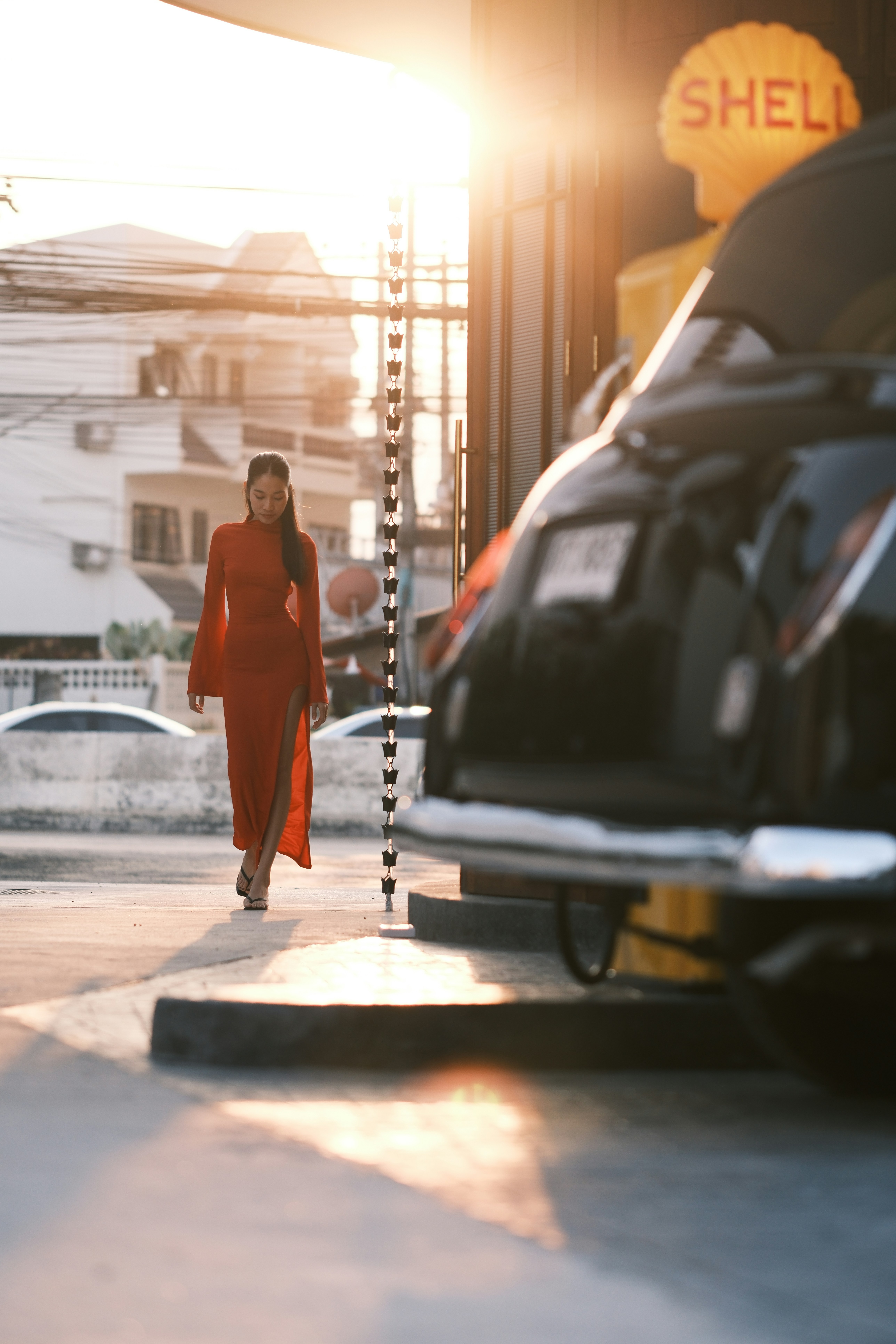 Golden Hour Silhouette: Red Dress on a Sunlit Street
