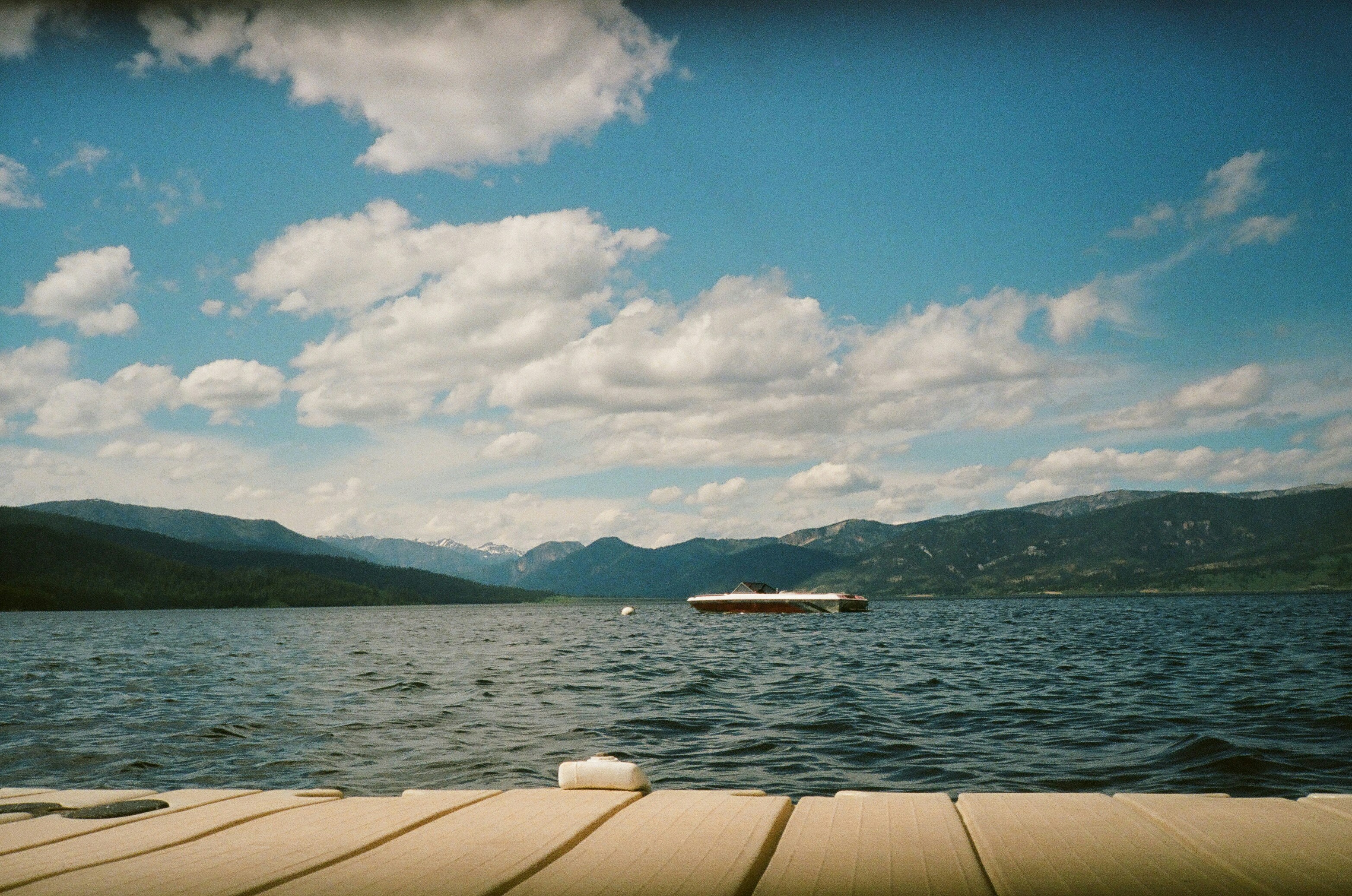 A boat floating on top of a large body of water photo – Free Beach ...