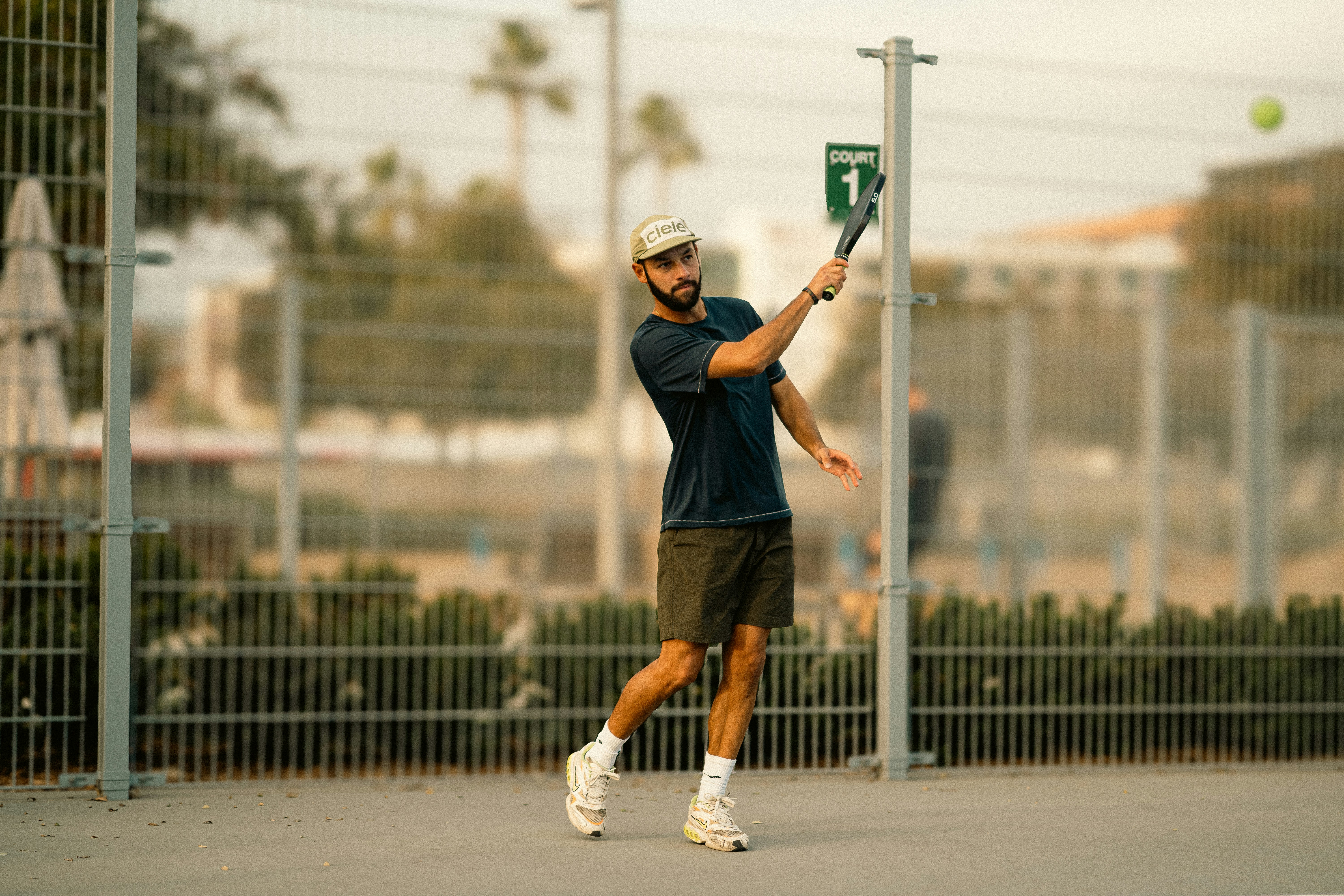 A man swinging a tennis racquet at a tennis ball photo – Free San diego ...