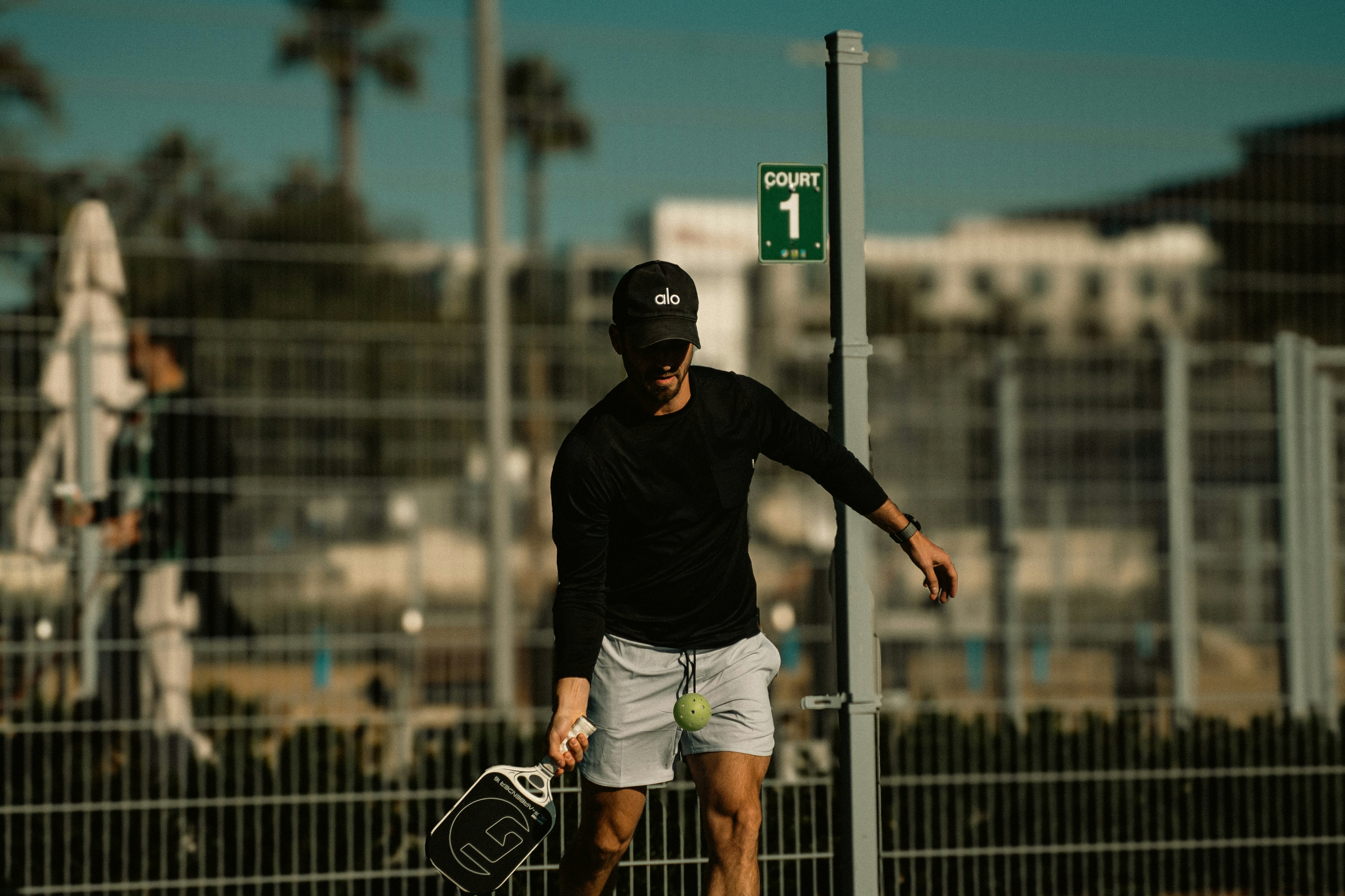 Precision in Motion on Court 1: A Player Aligns for a Low, Floating Return