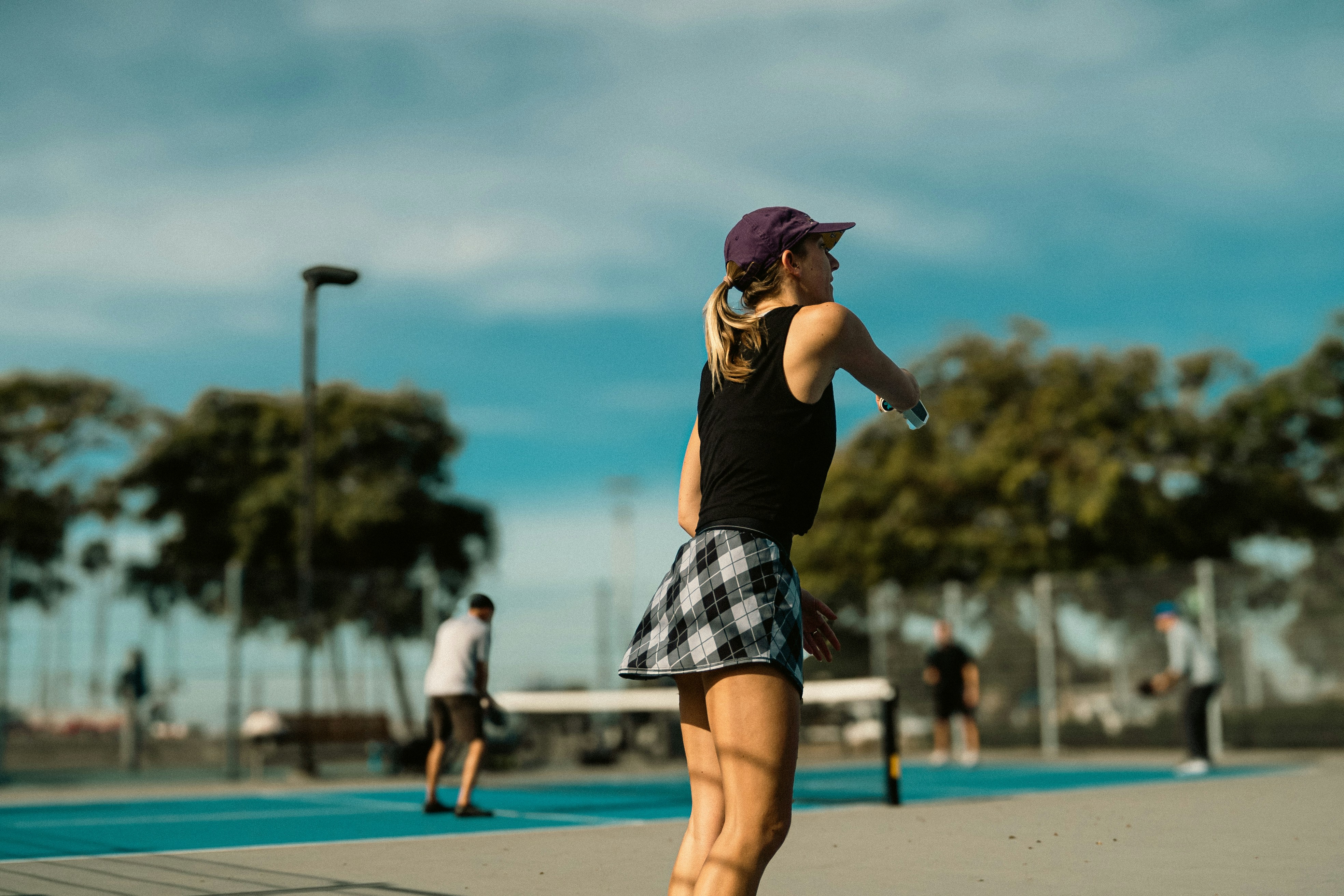 Runner in a Leisure Court: Focus on a sunlit athlete mid-action