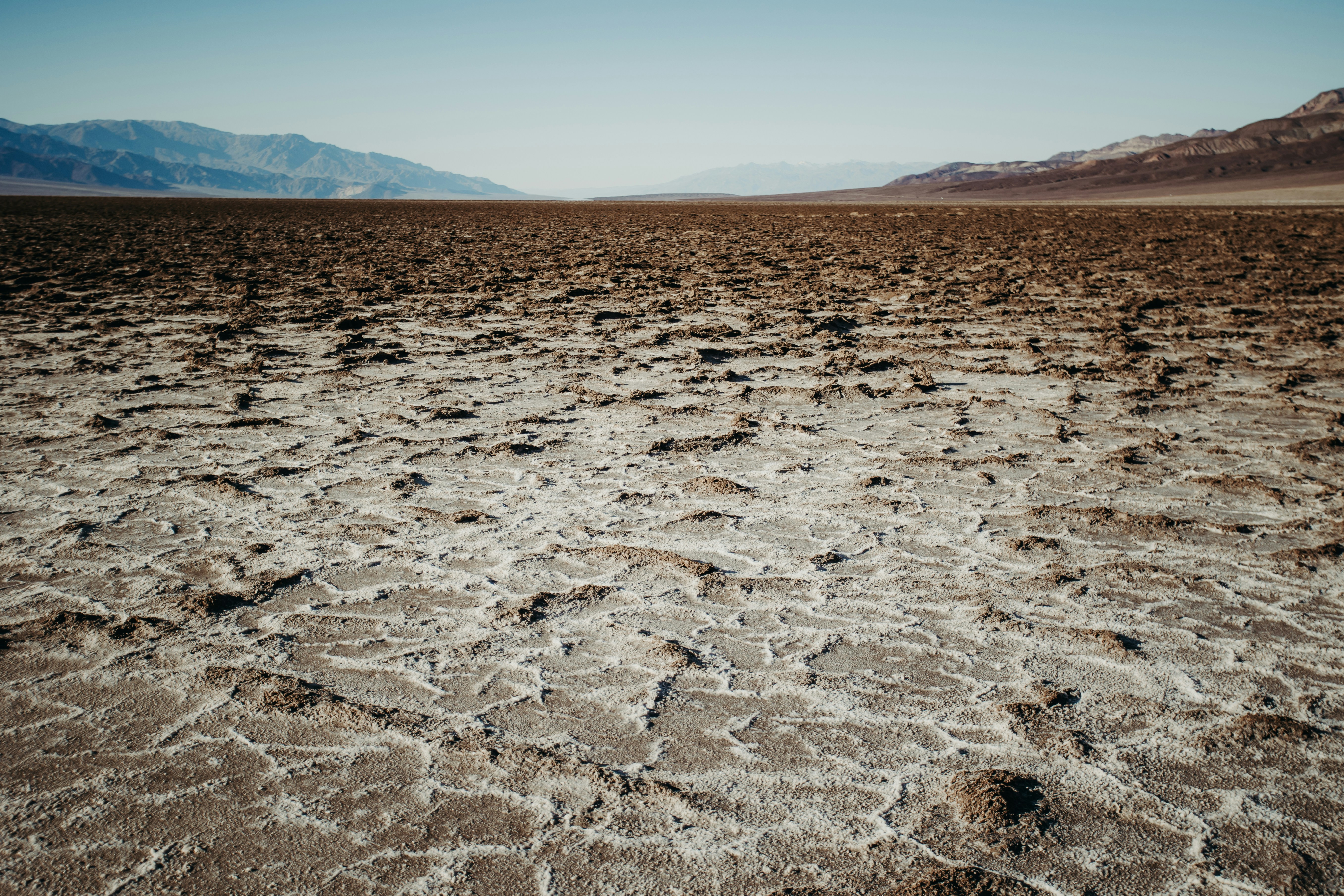 A barren area with mountains in the distance photo – Free Land Image on ...