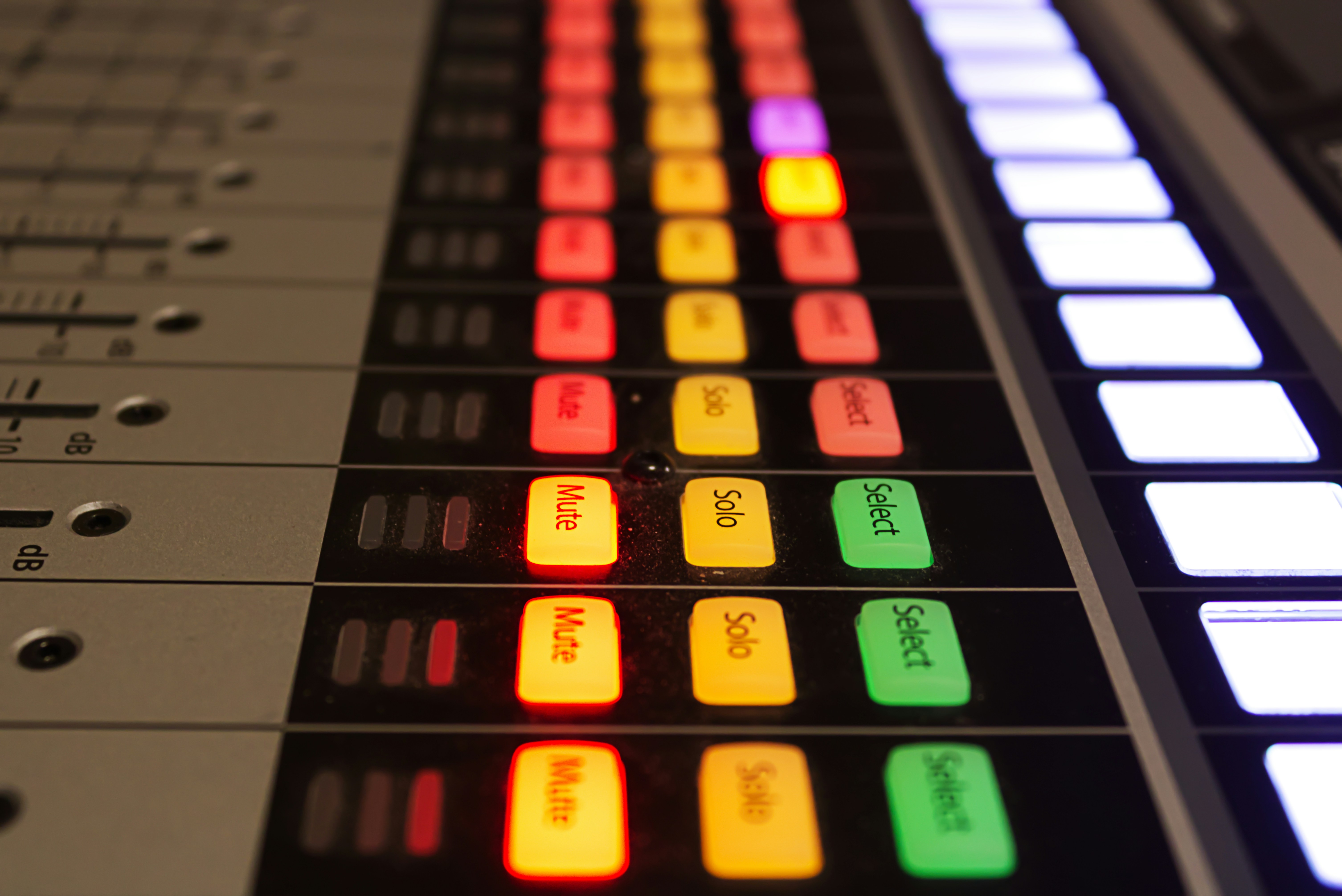 Mute Matrix: Neon Buttons on a Studio Console in Focus