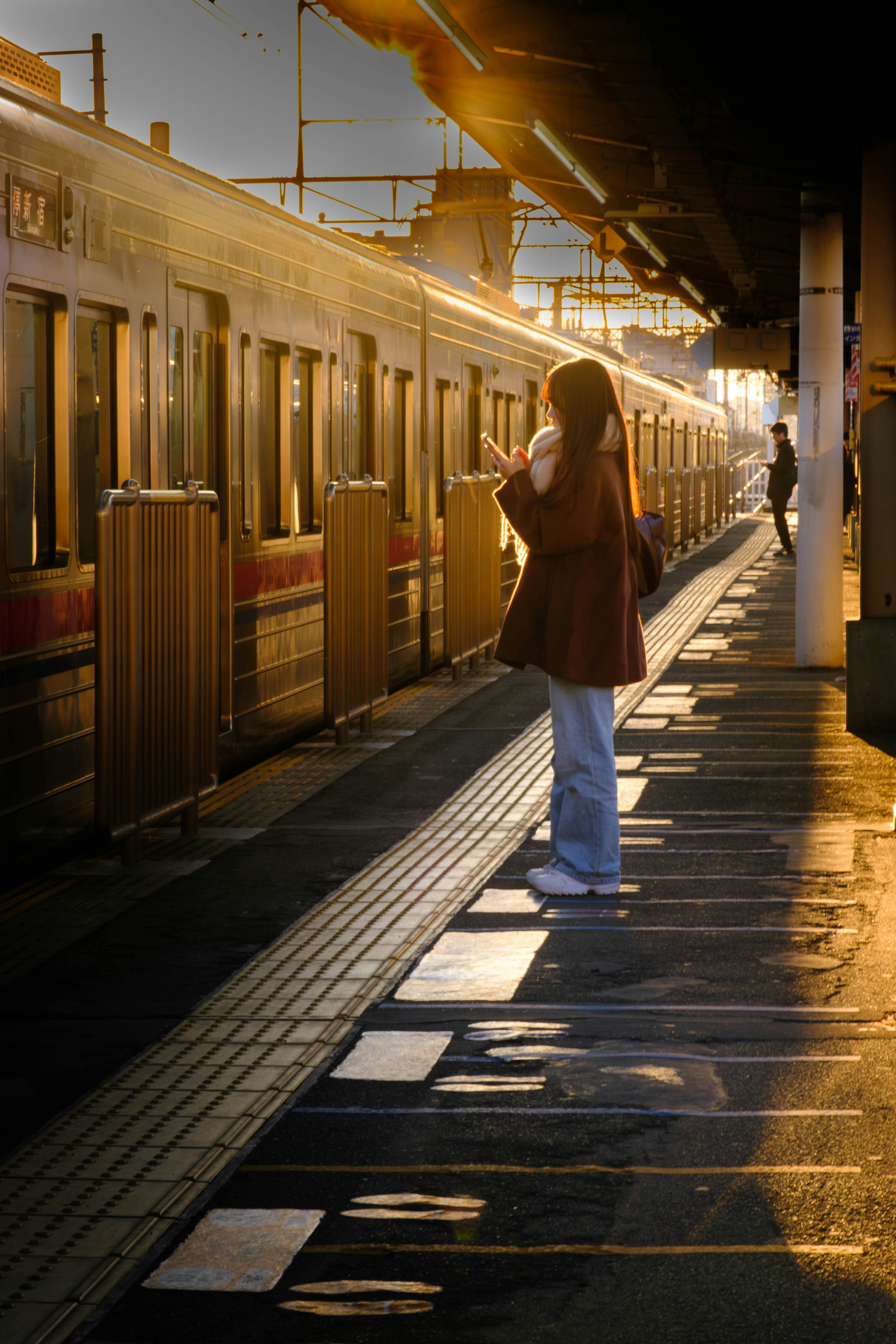 Golden Hour at the Platform: A Passenger Figures in Quiet Focus