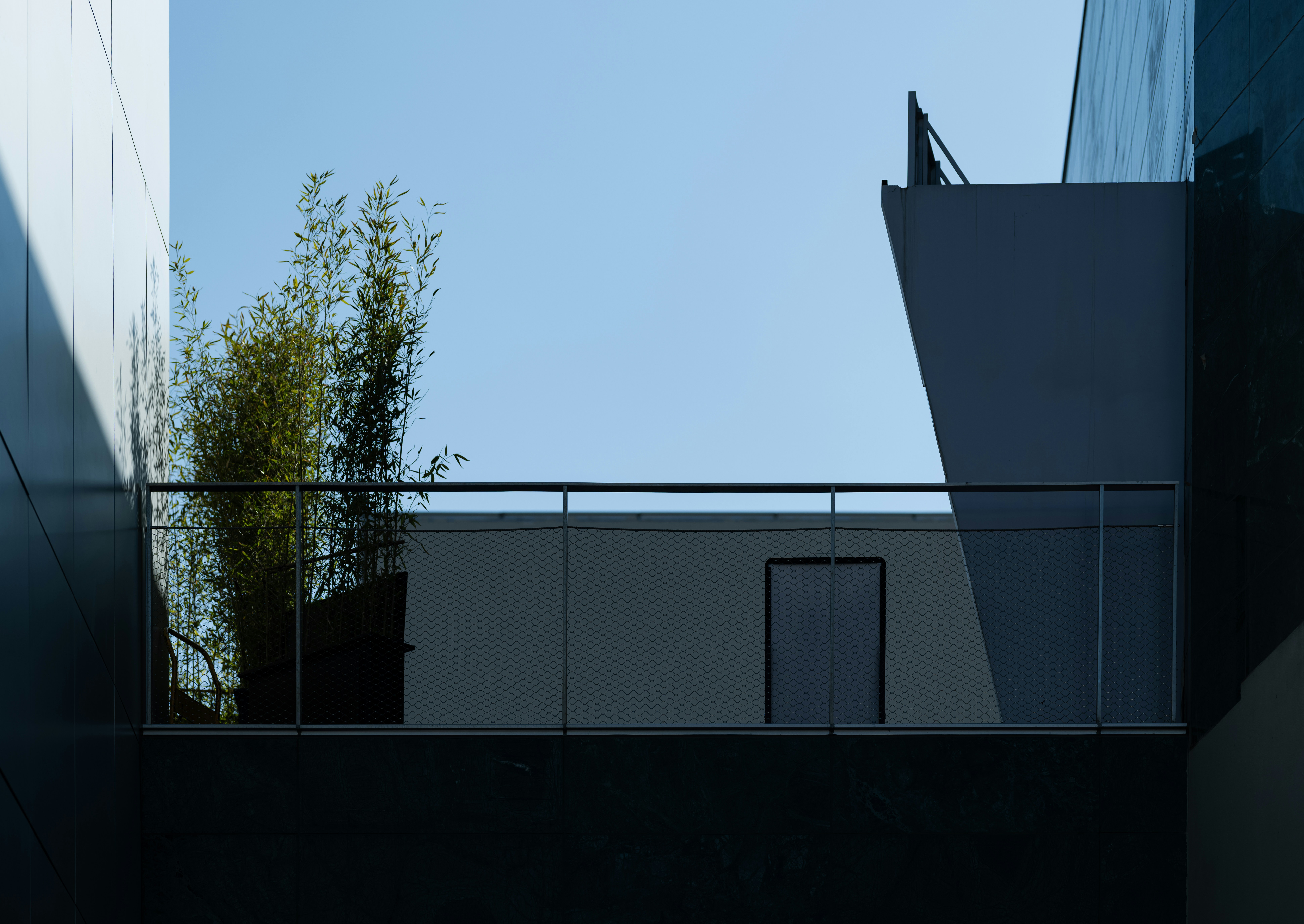 Centered window under a glass railing: a study in modern geometry