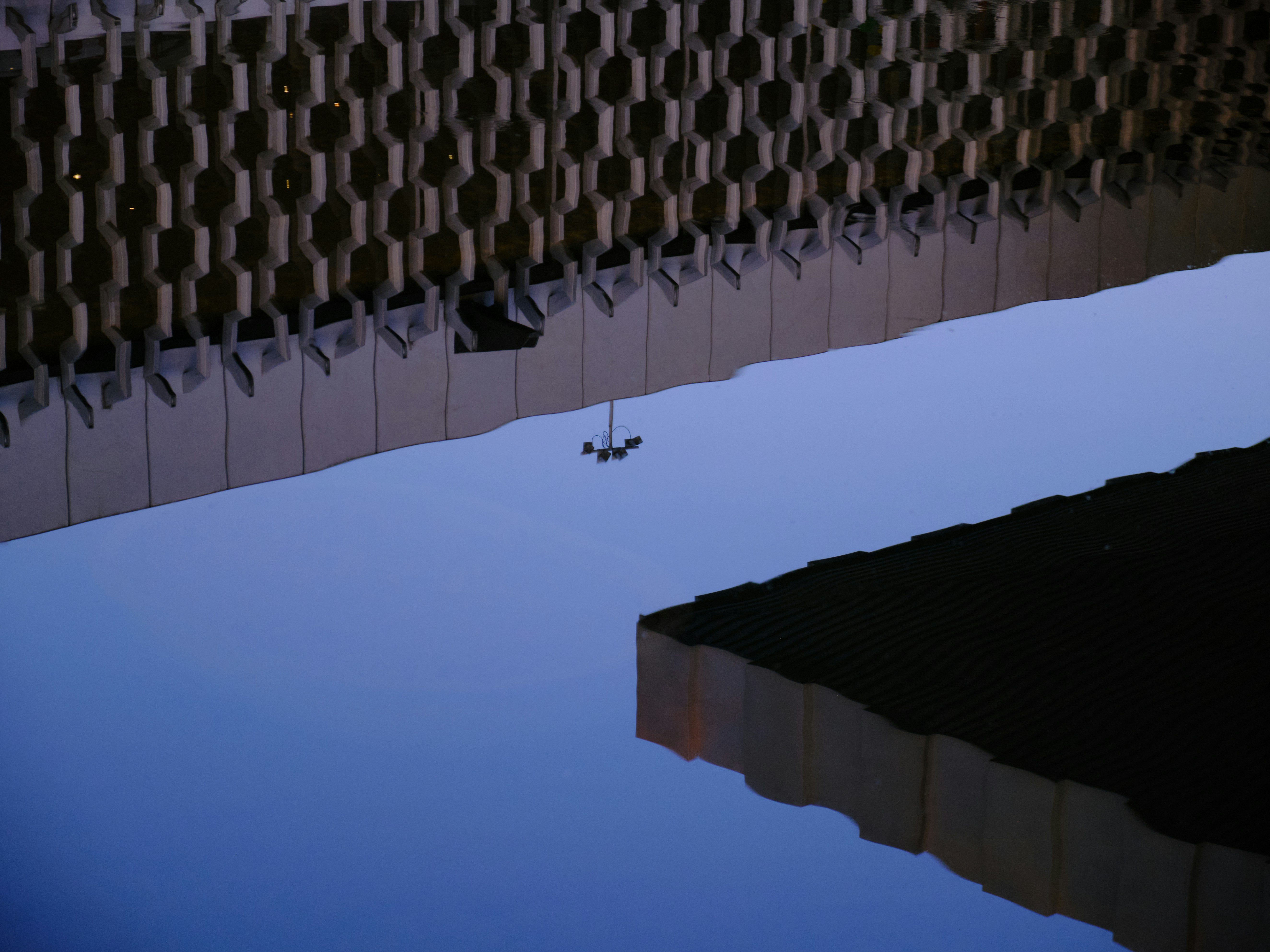 Blue Echoes Along the Facade: A Quiet Reflection