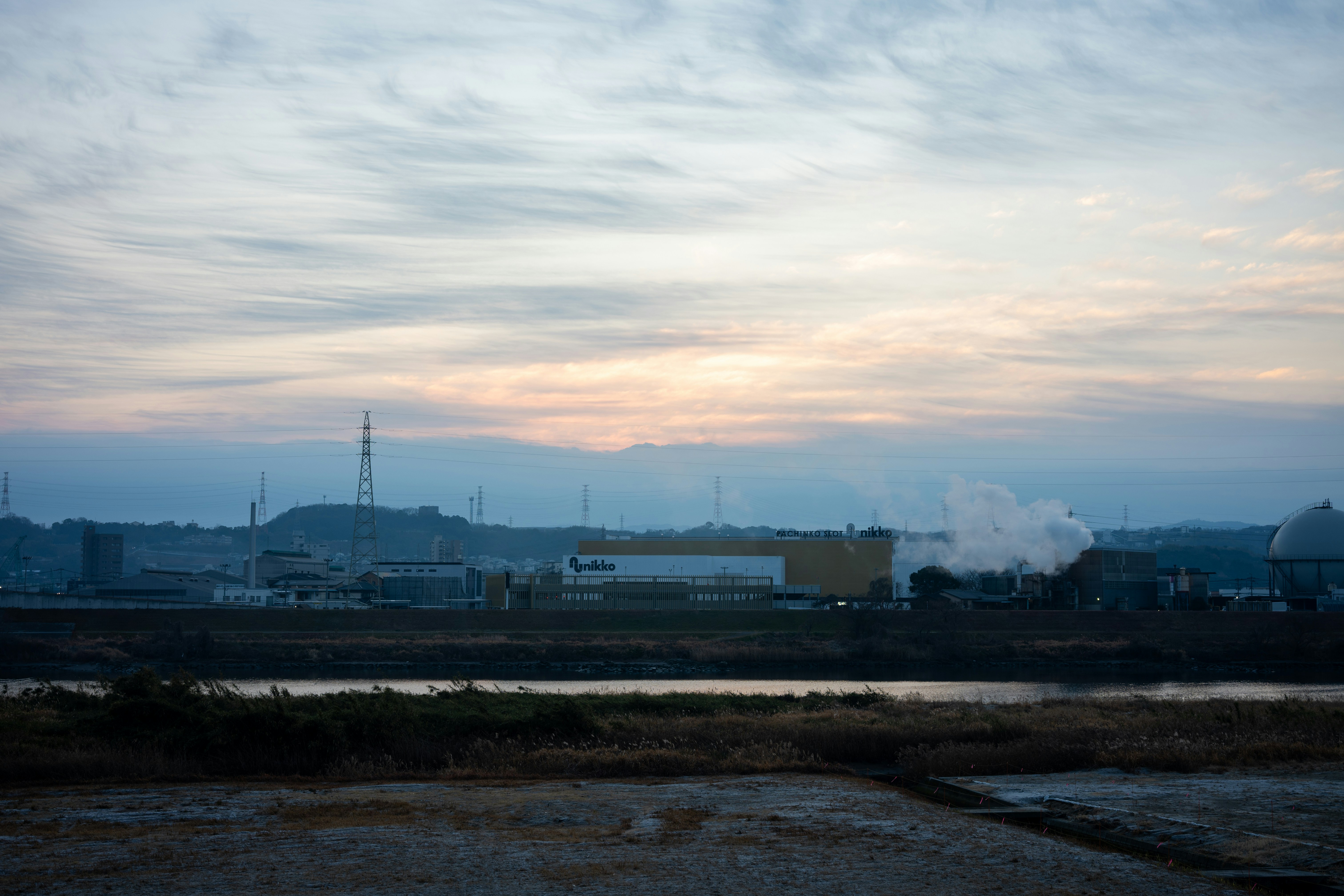 Dawn’s Quiet Horizon: Steam and Silhouette Over an Industrial Waterfront