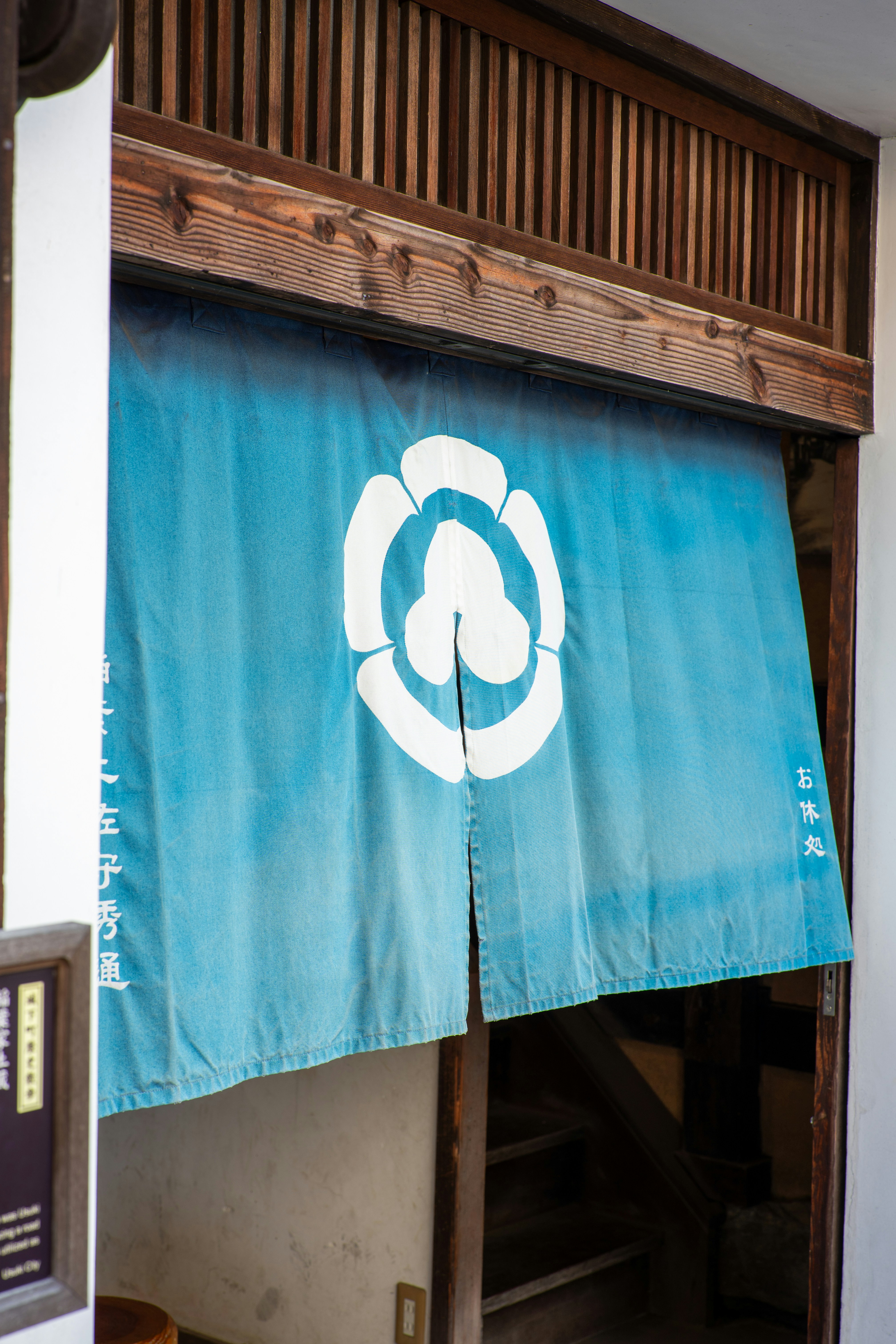A large blue flag hanging from the side of a building photo – Free Flag ...