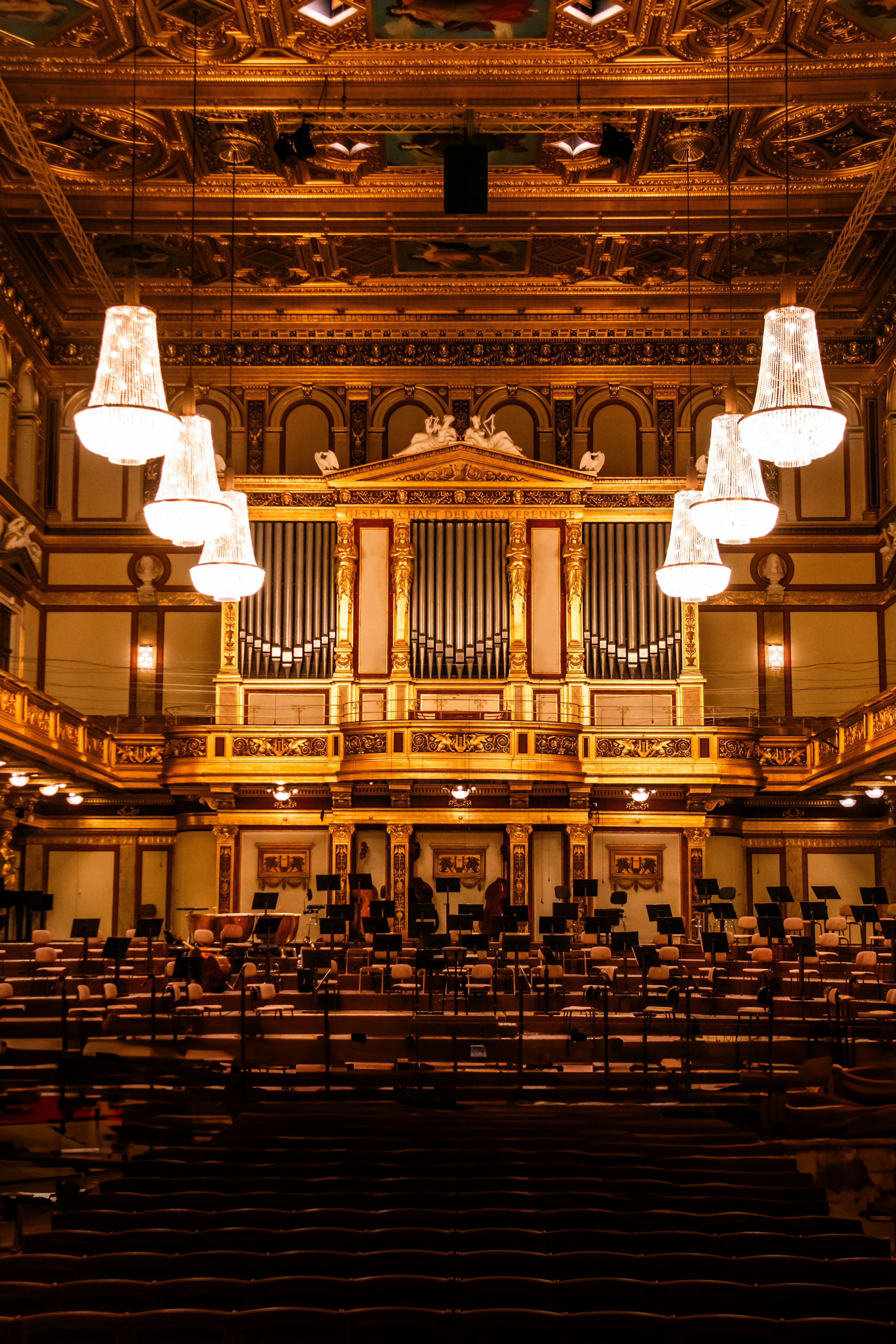 A concert hall with a pipe organ and chandeliers photo – Free Building ...