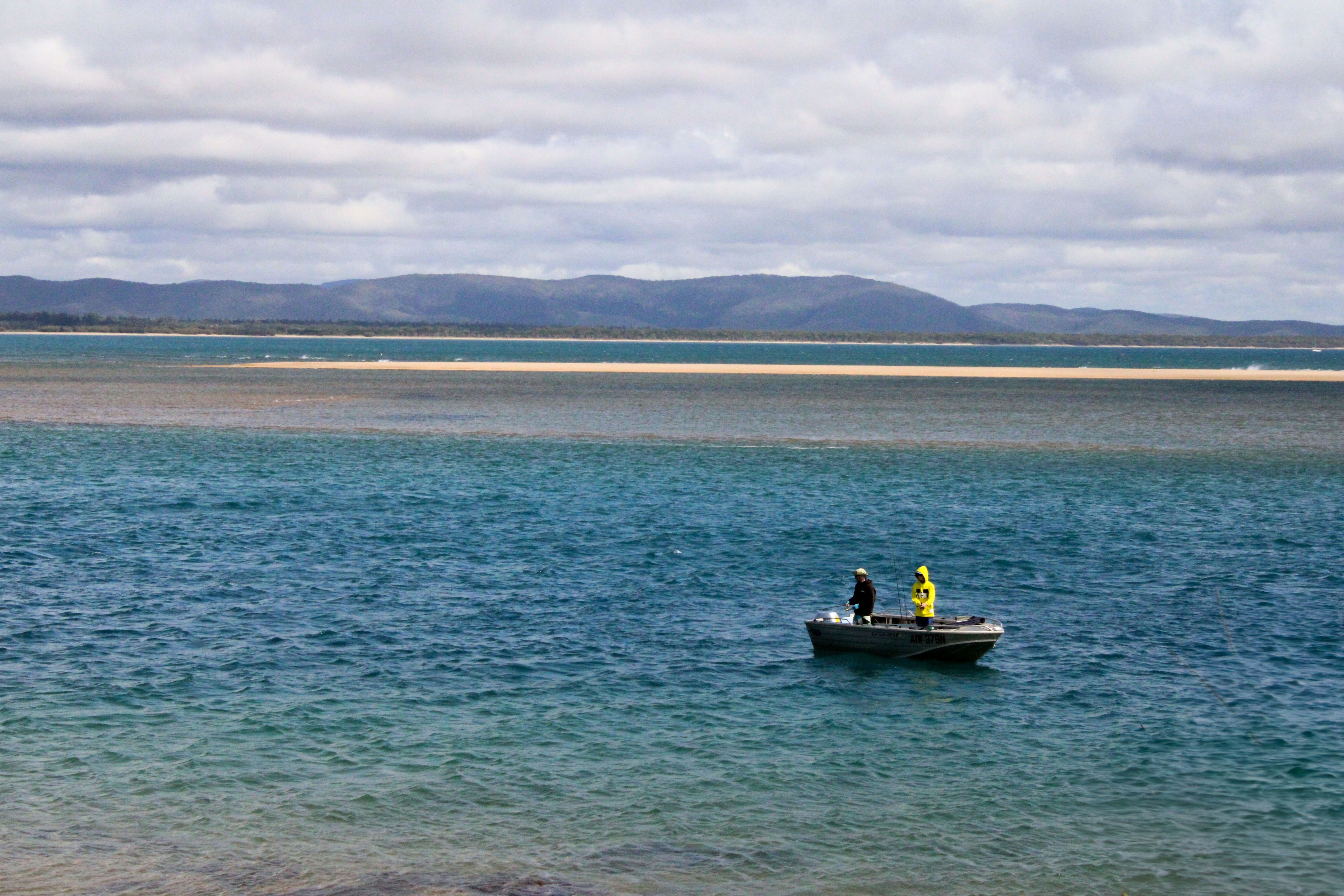 Boat on turquoise shallows: a quiet coastal moment