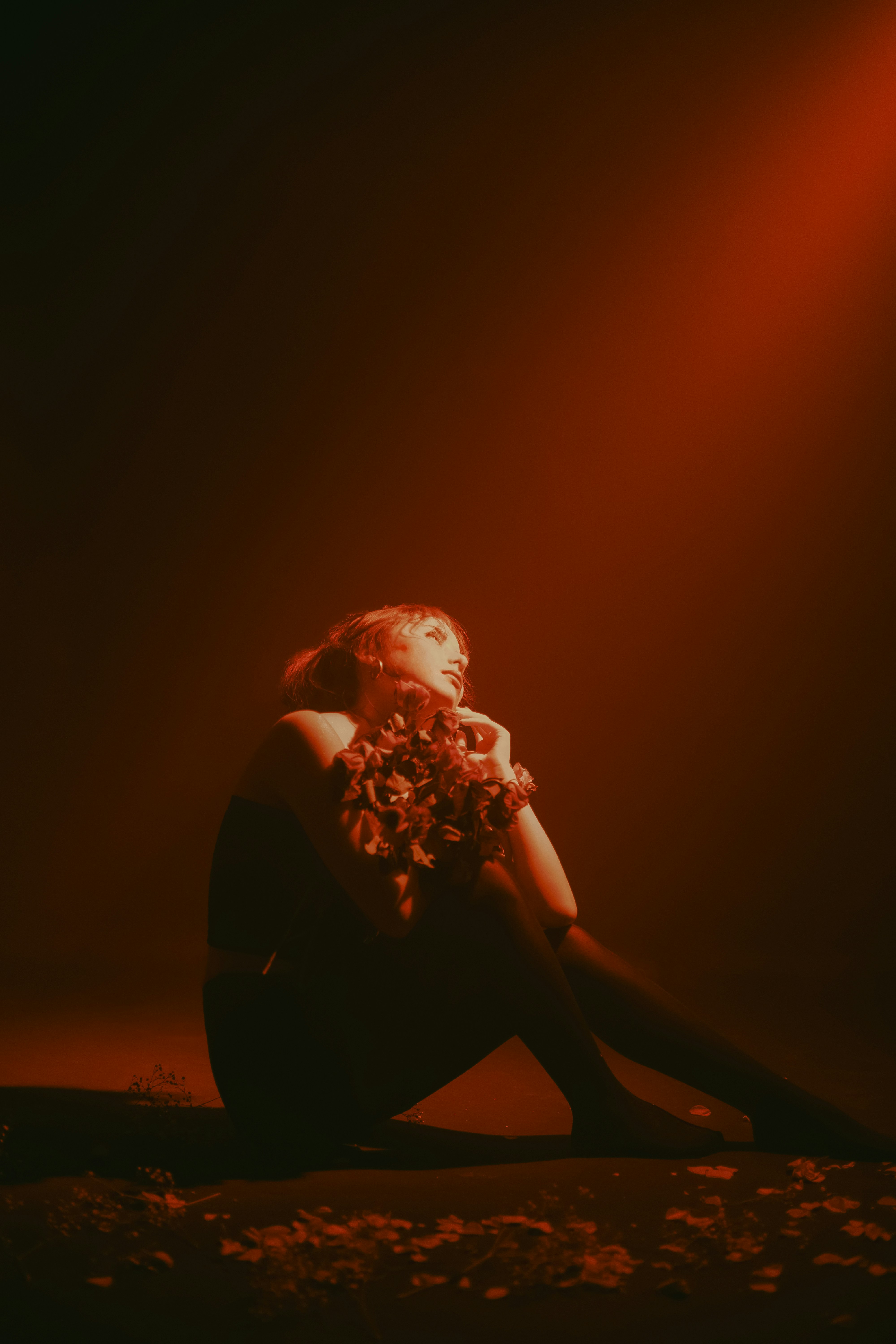 A woman sitting on the ground with her legs crossed photo – Free Raw ...