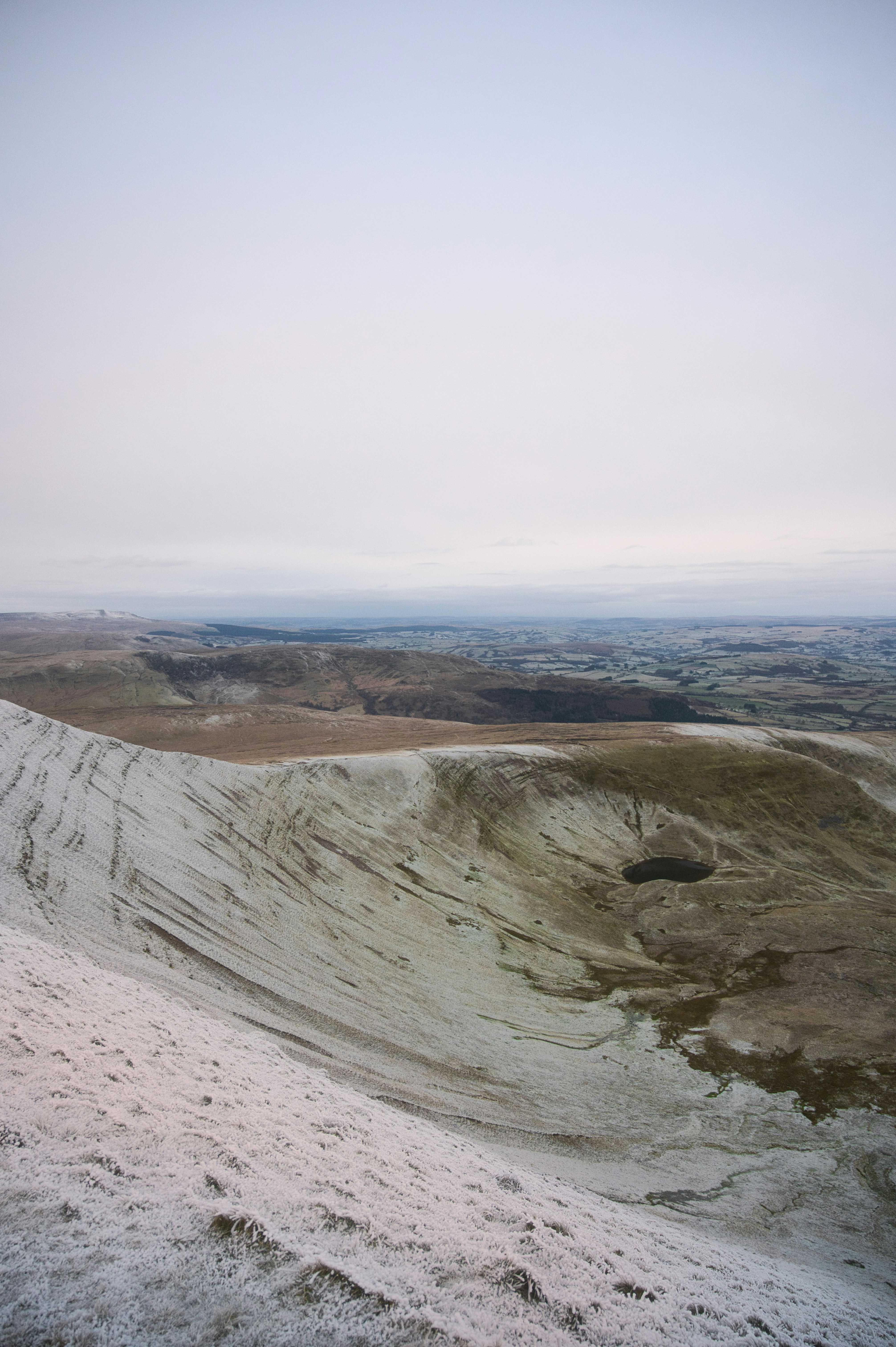 A person standing on top of a snow covered hill