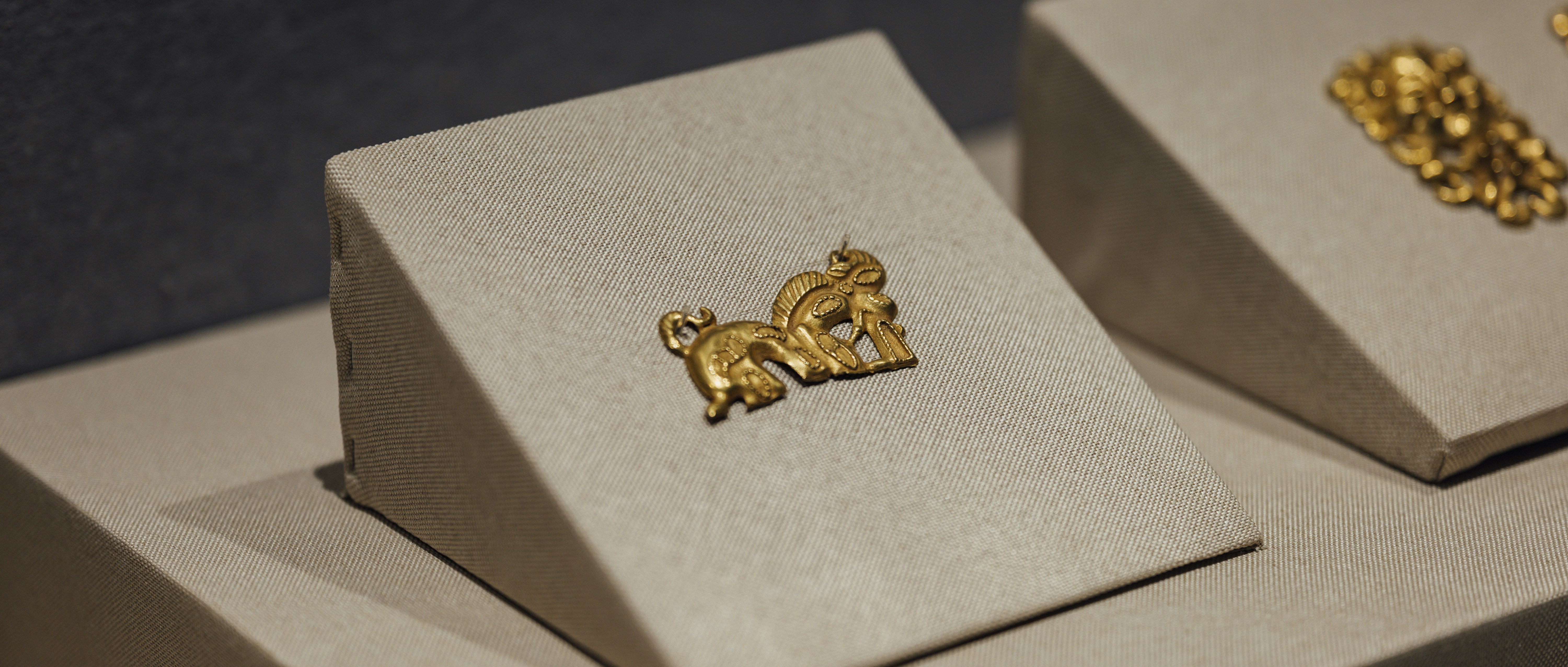 Golden Crest on Velvet Pedestal: a Tiny Animal Brooch