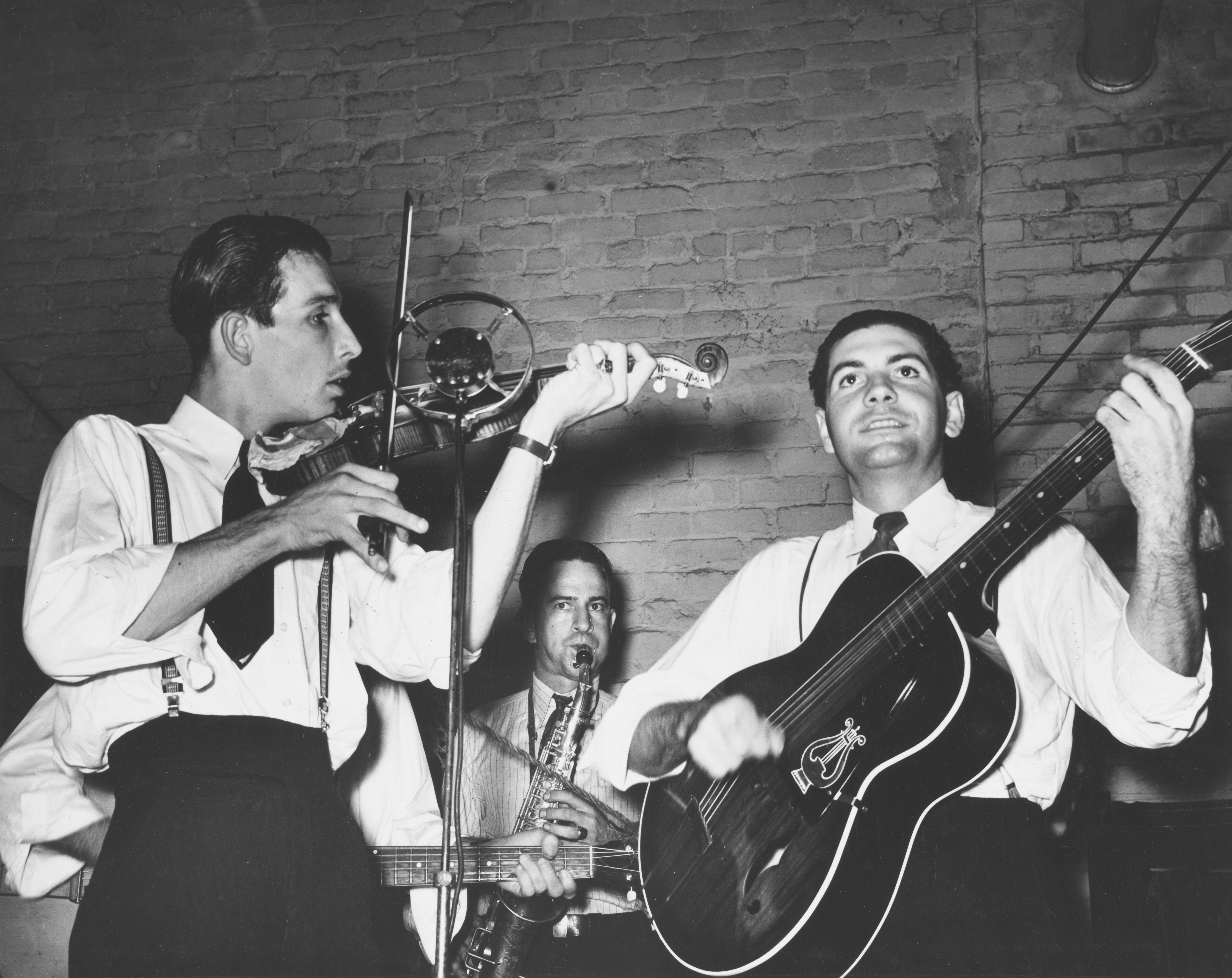 Three musicians passionately performing in a lively setting, featuring a violinist, saxophonist, and guitarist. Their expressions convey the energy of the moment.
