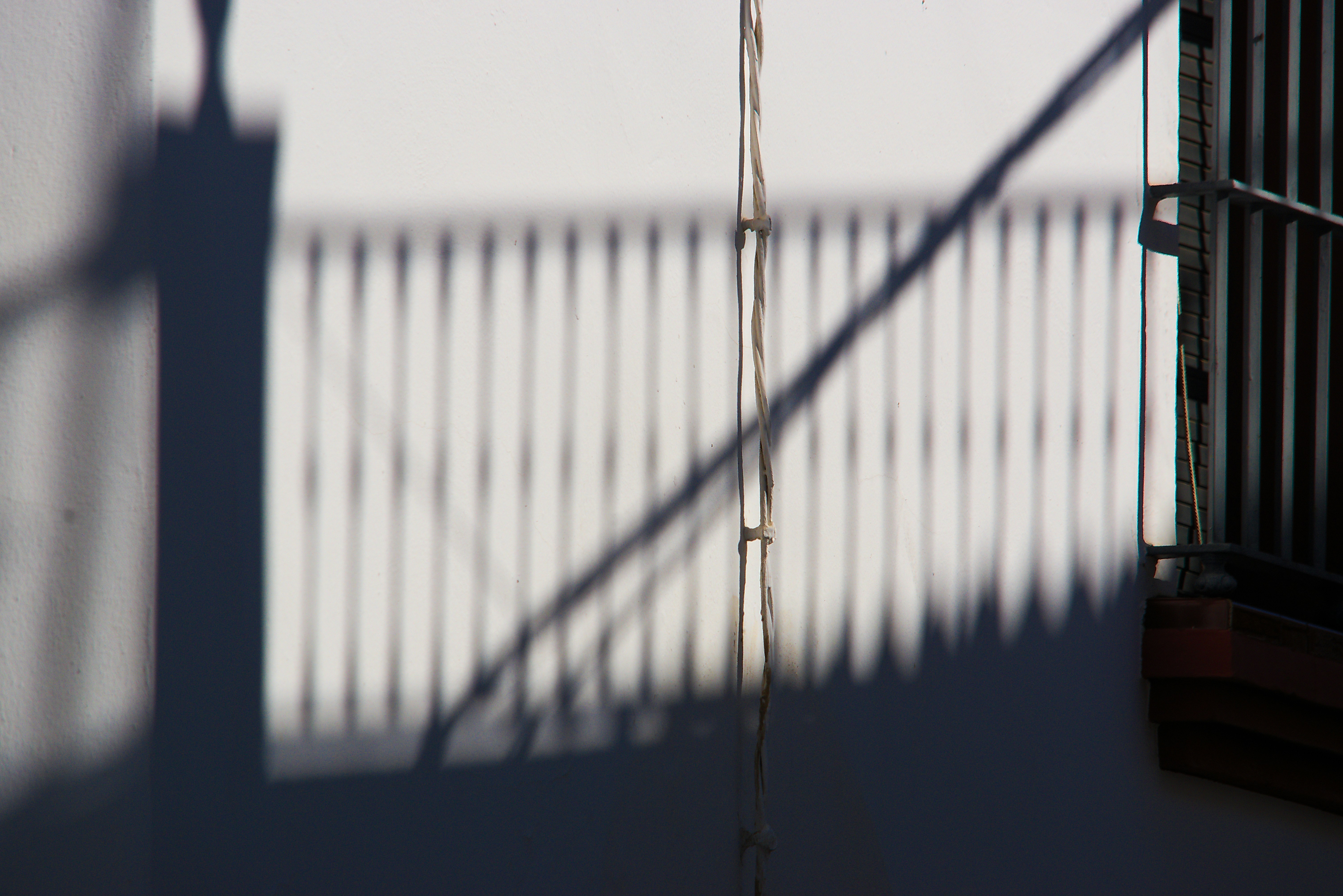Shadowed Lines Across a sunlit Wall