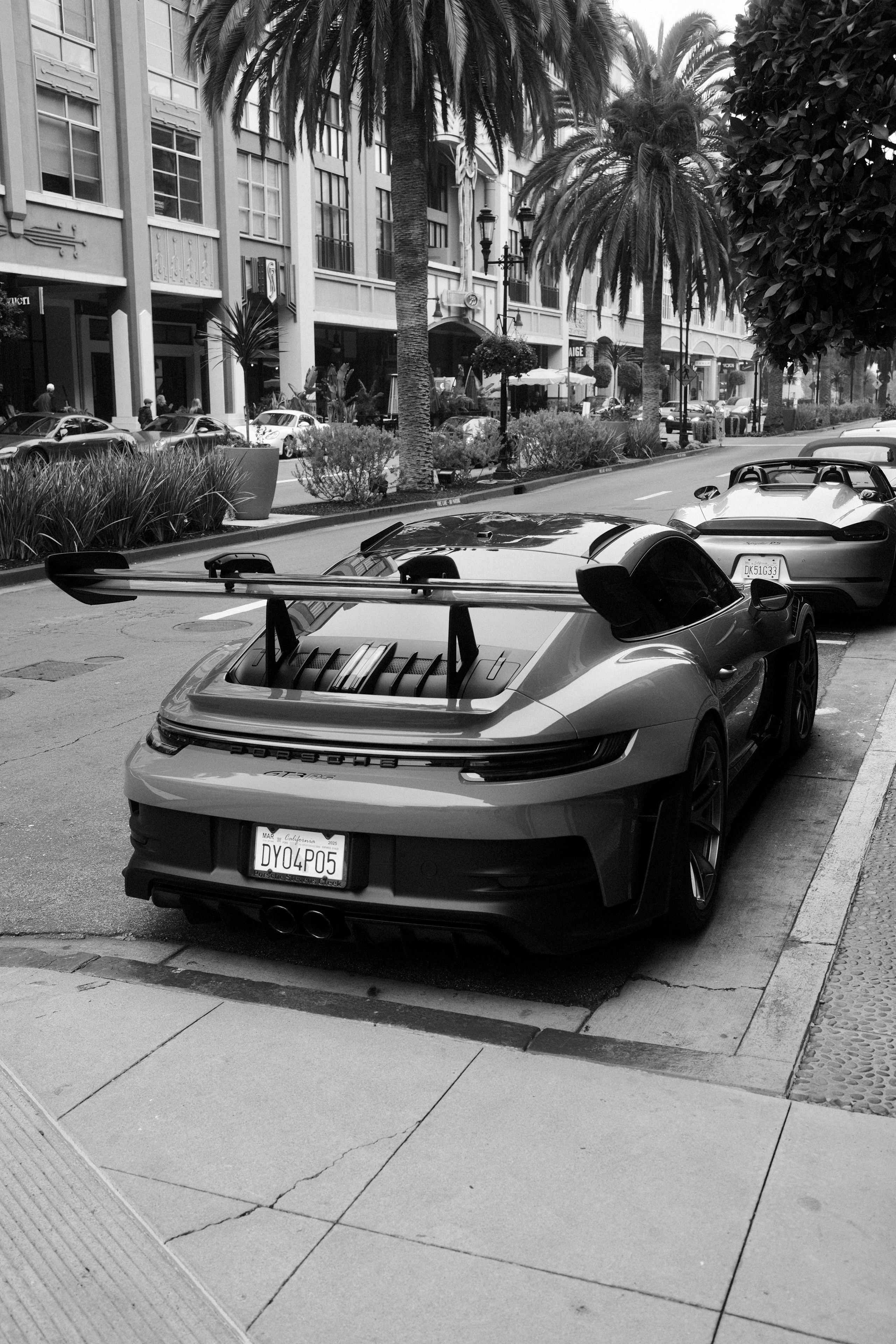 Rear-Wing Reverie on Palm Street: A Porsche 911 in Monochrome