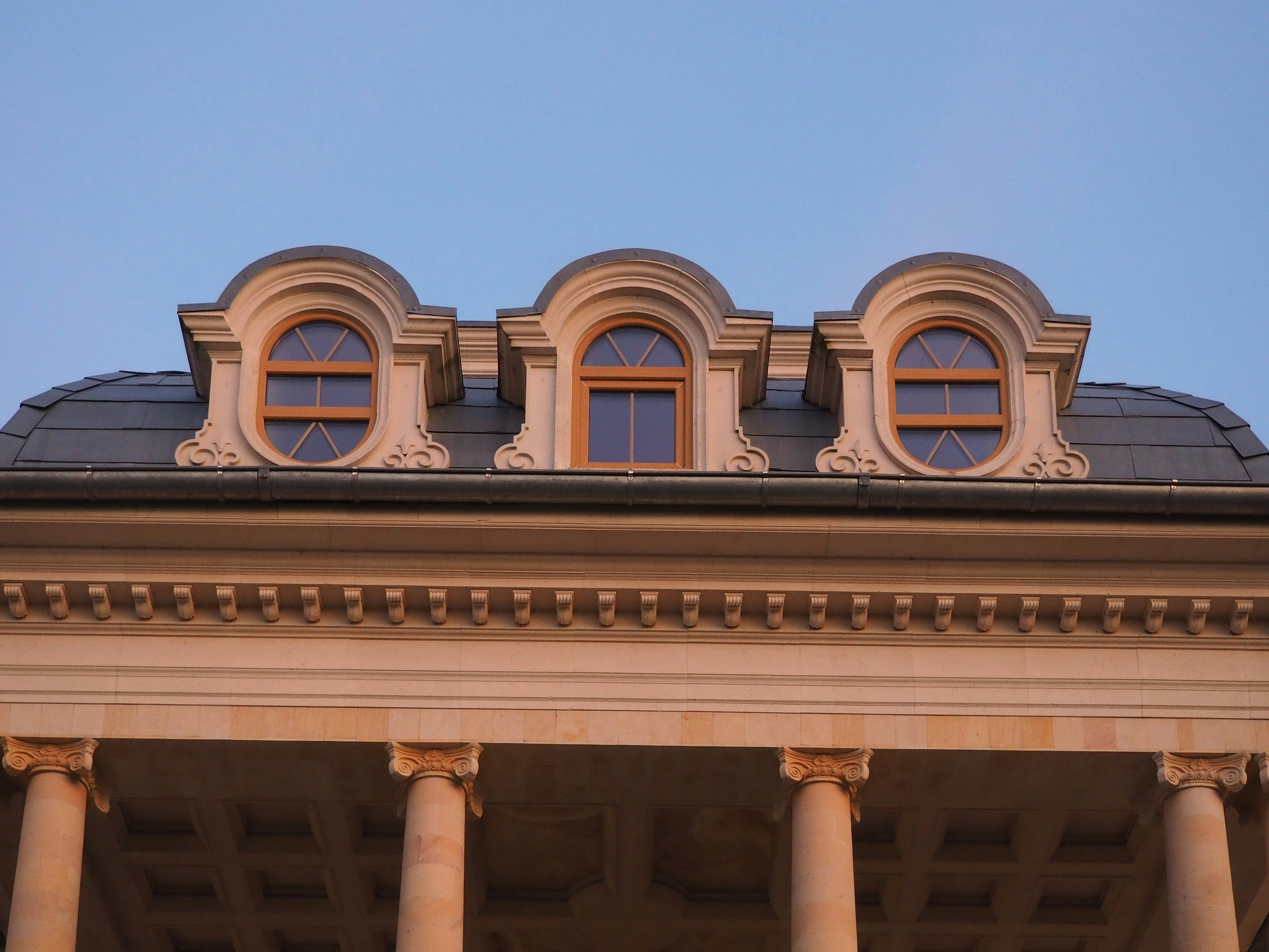 Ornate Dormer Suite: Classical Architecture in Soft Sunlight