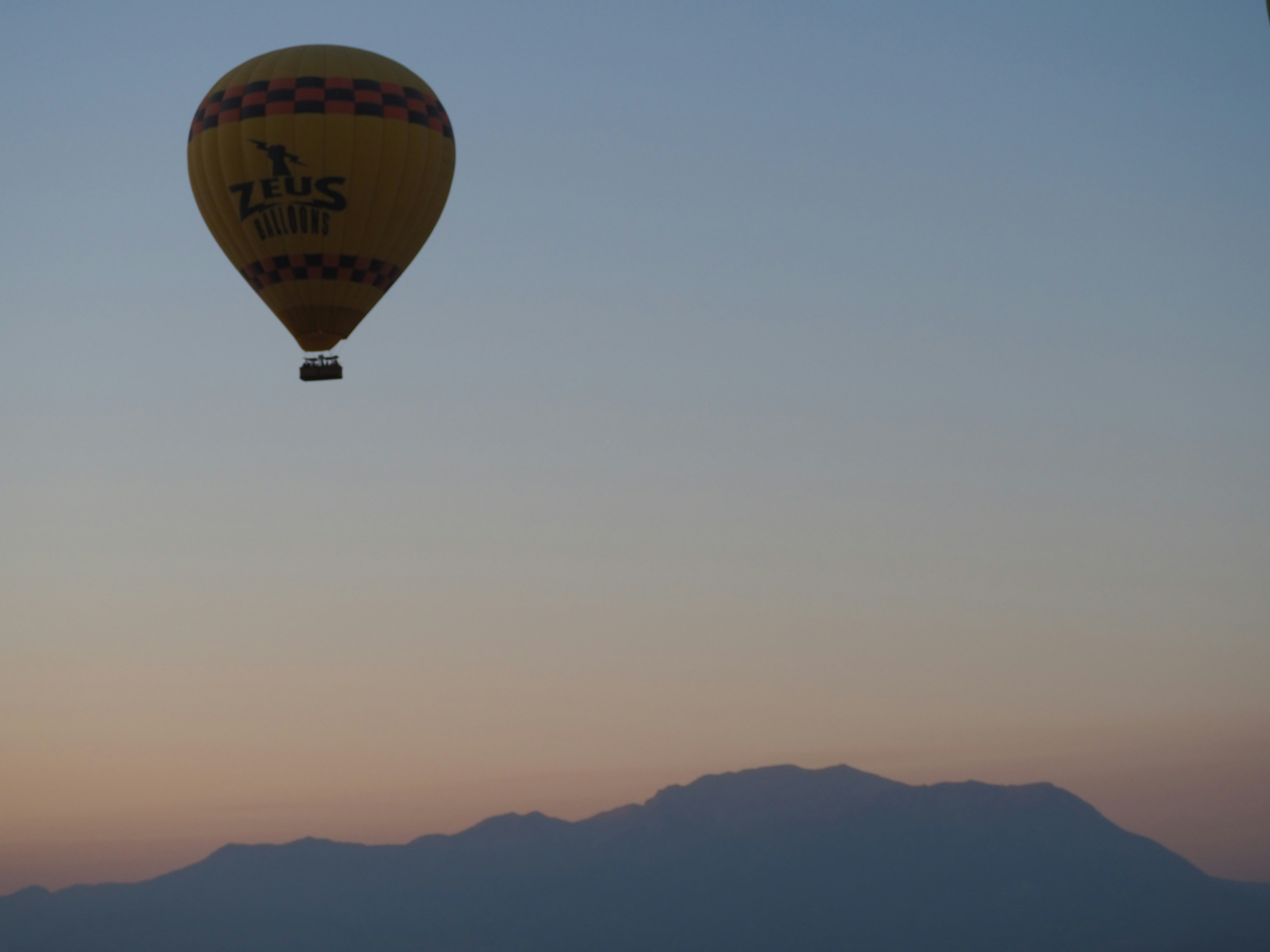 Dusk Glide Over a Silhouetted Ridge